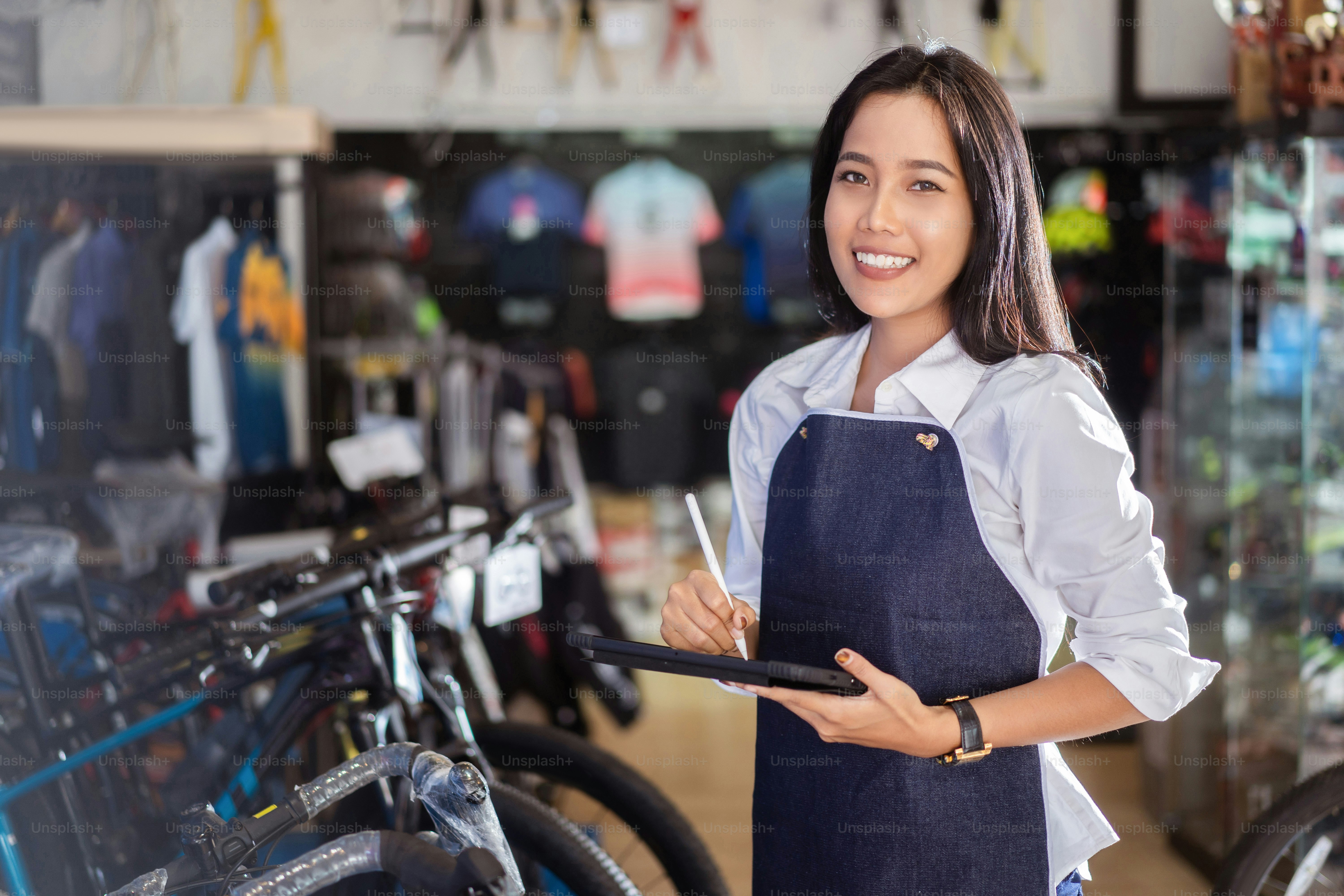 Bicycle salesman is advising customers to choose bikes. photo ...