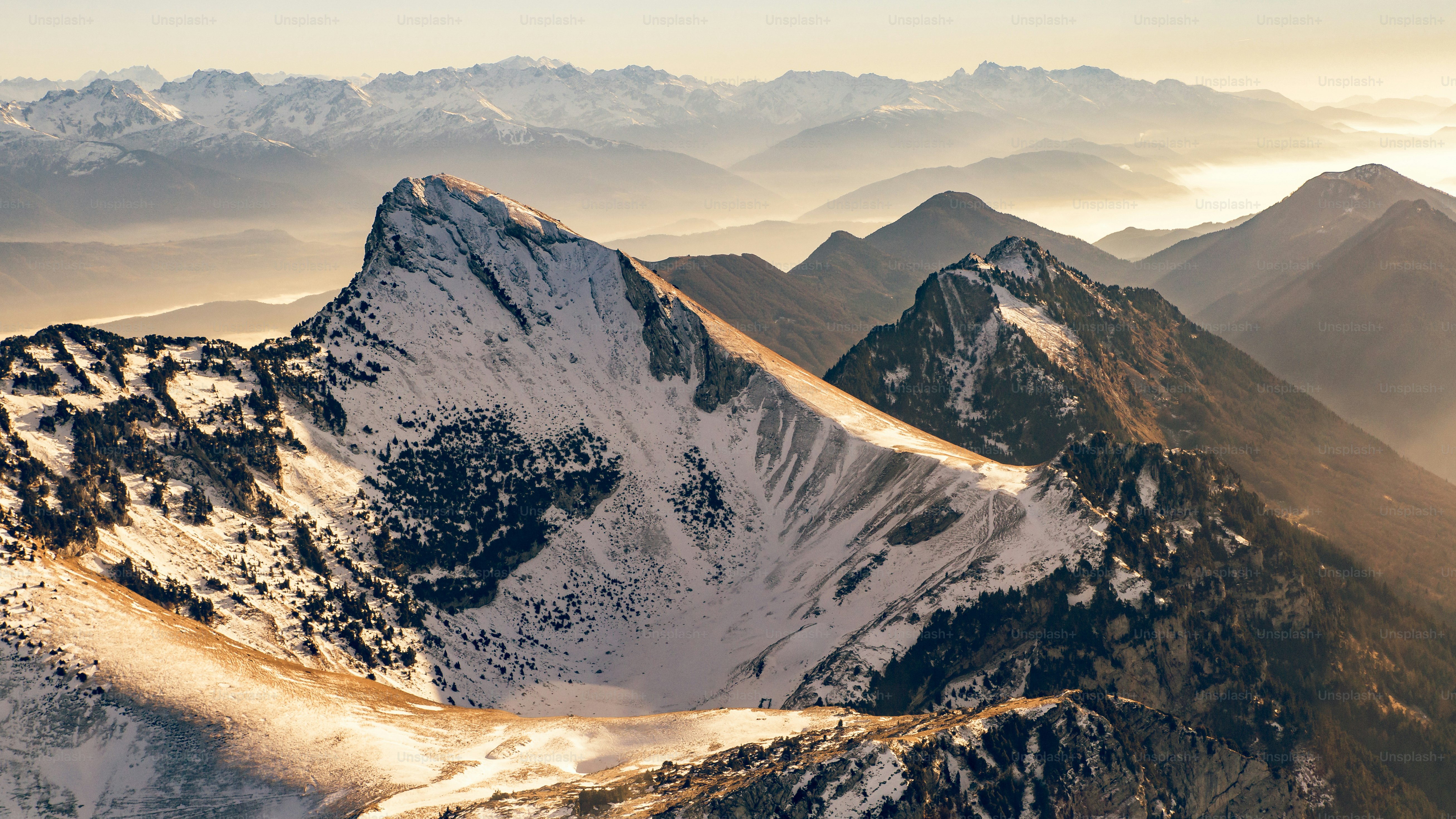 A mountain range covered in snow photo – Sunset Image on Unsplash