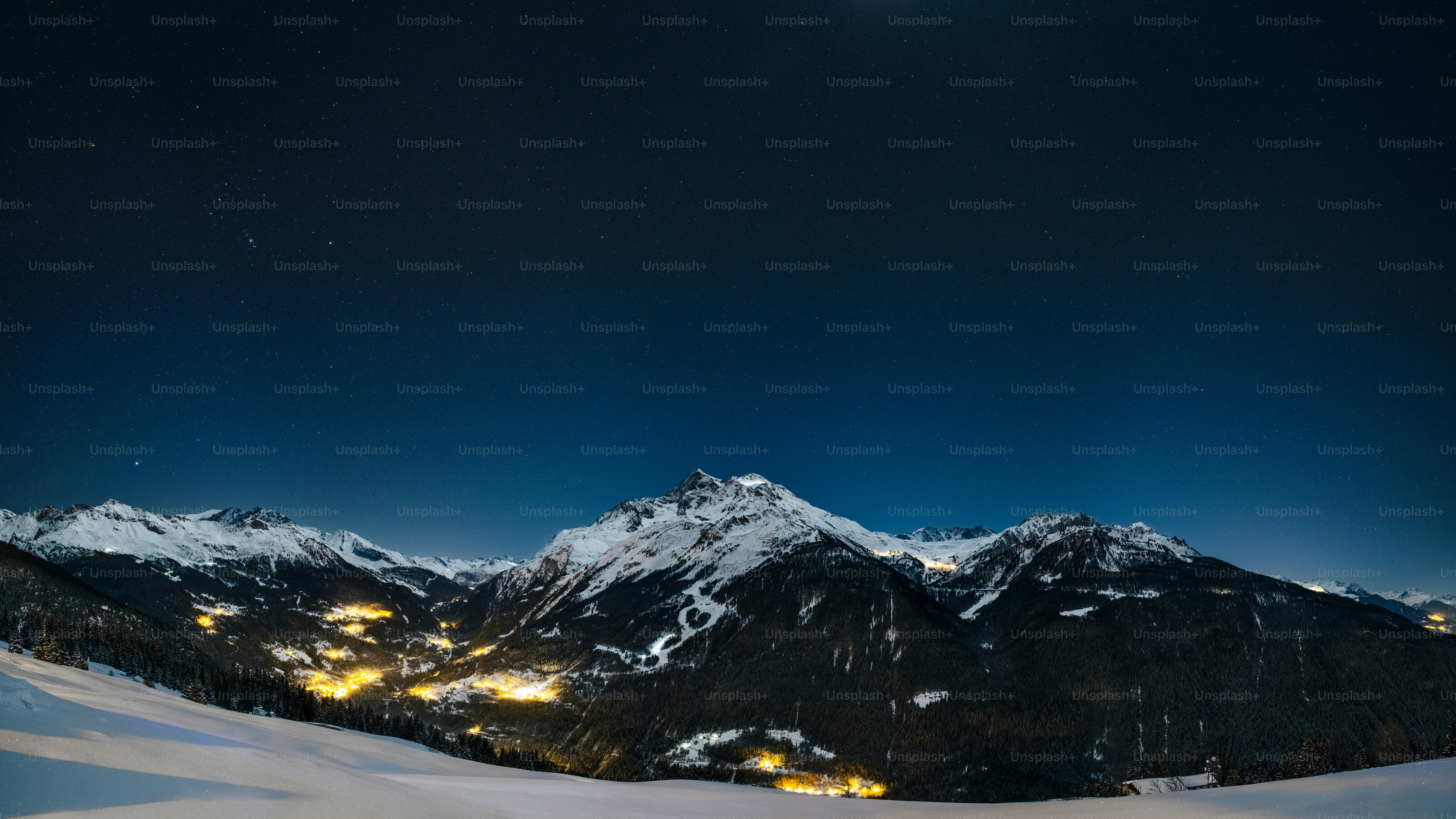 A snowy mountain range at night photo – Winter Image on Unsplash