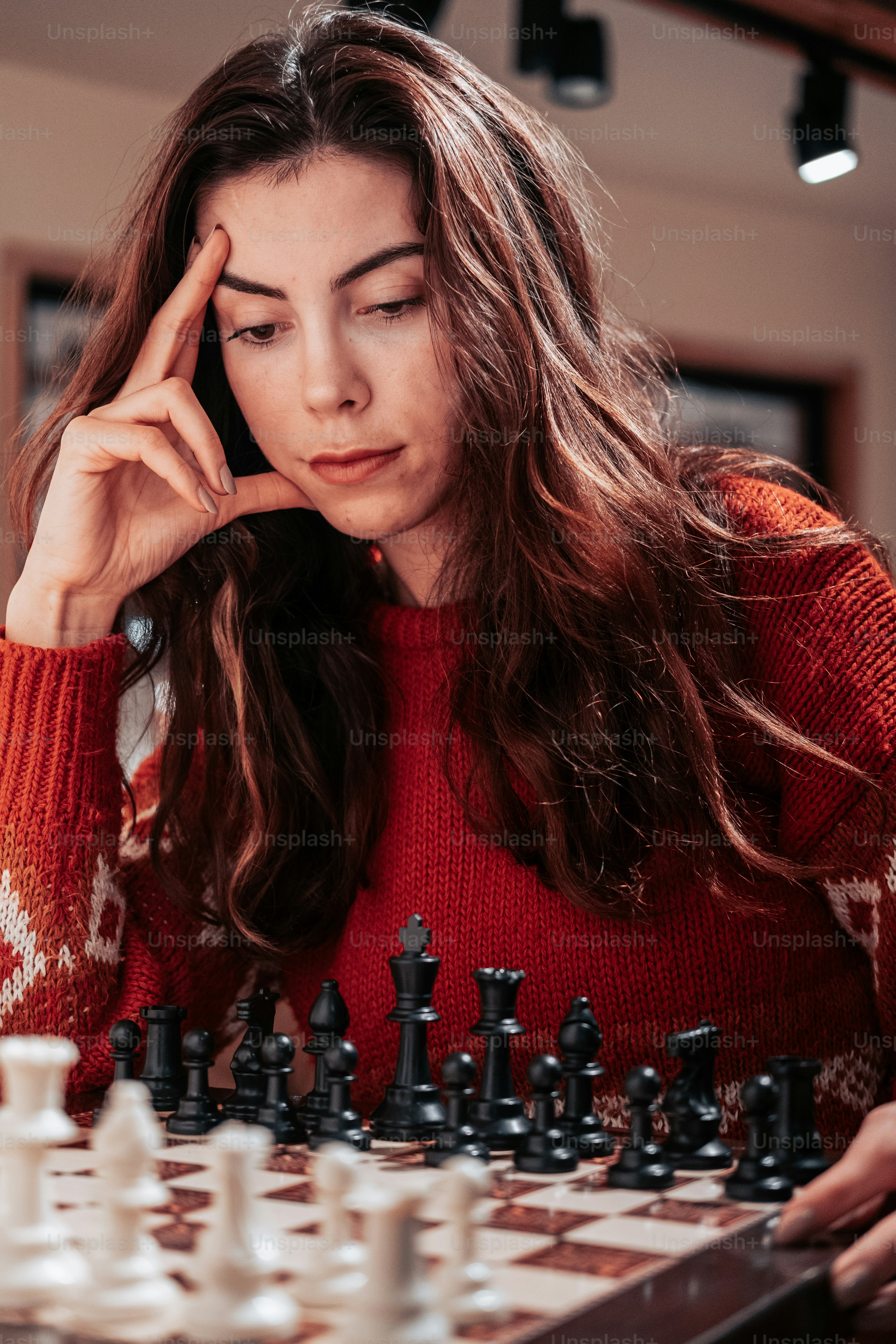 A woman with her hand on her face and a chess board photo – Chess Image ...