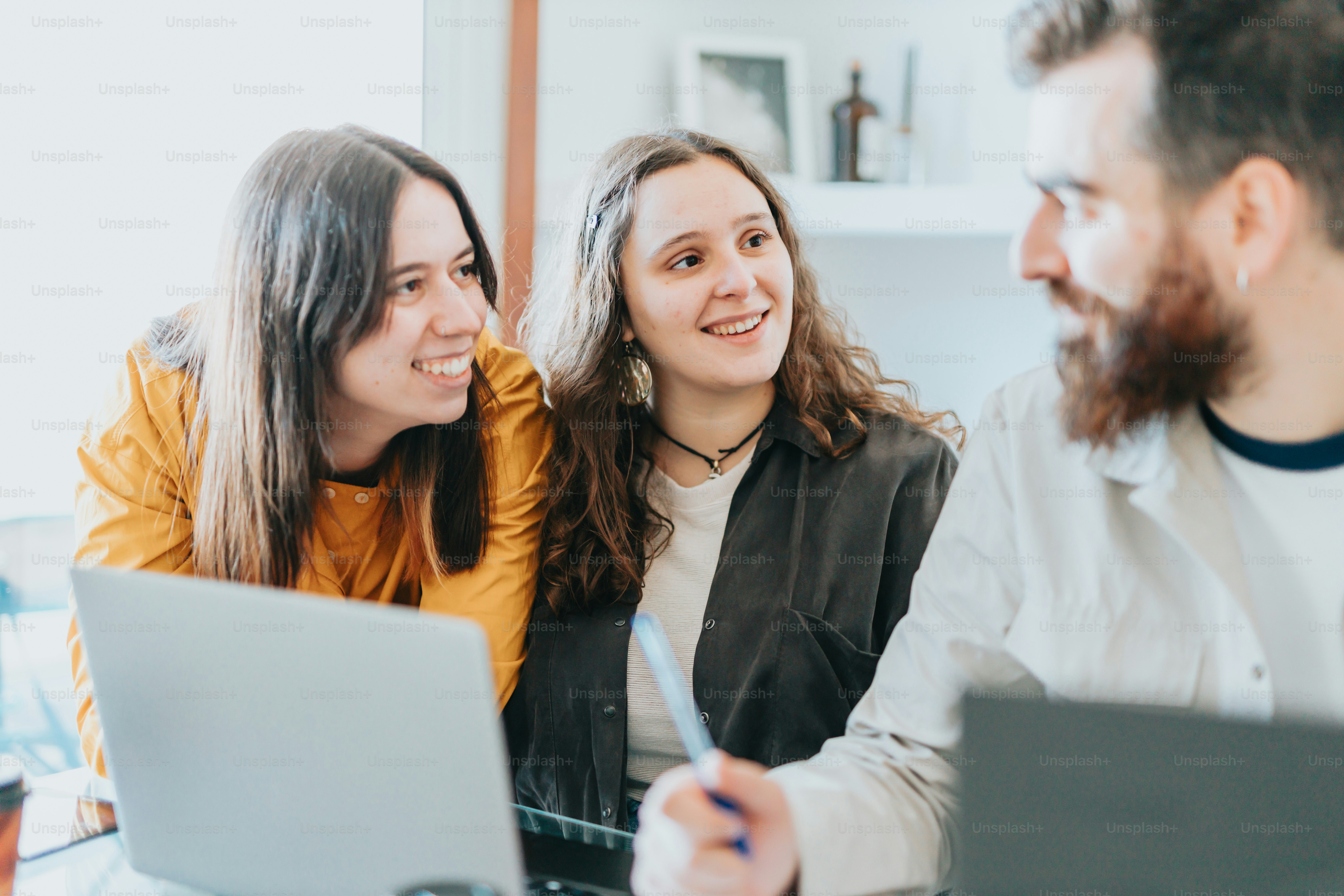 A group of people looking at a laptop photo – Spend time Image on Unsplash