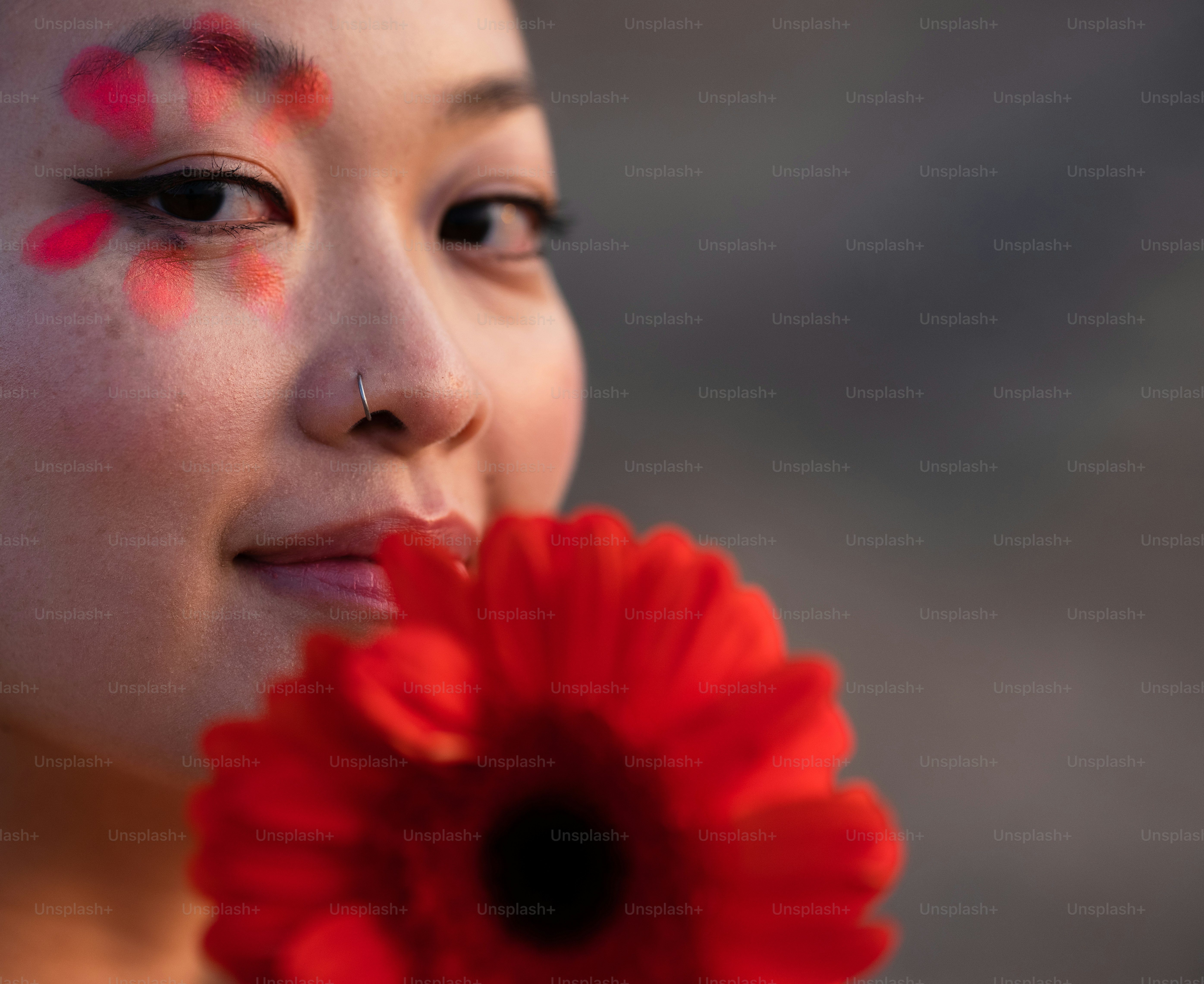 A person with a red flower in the mouth photo – Flower Image on Unsplash
