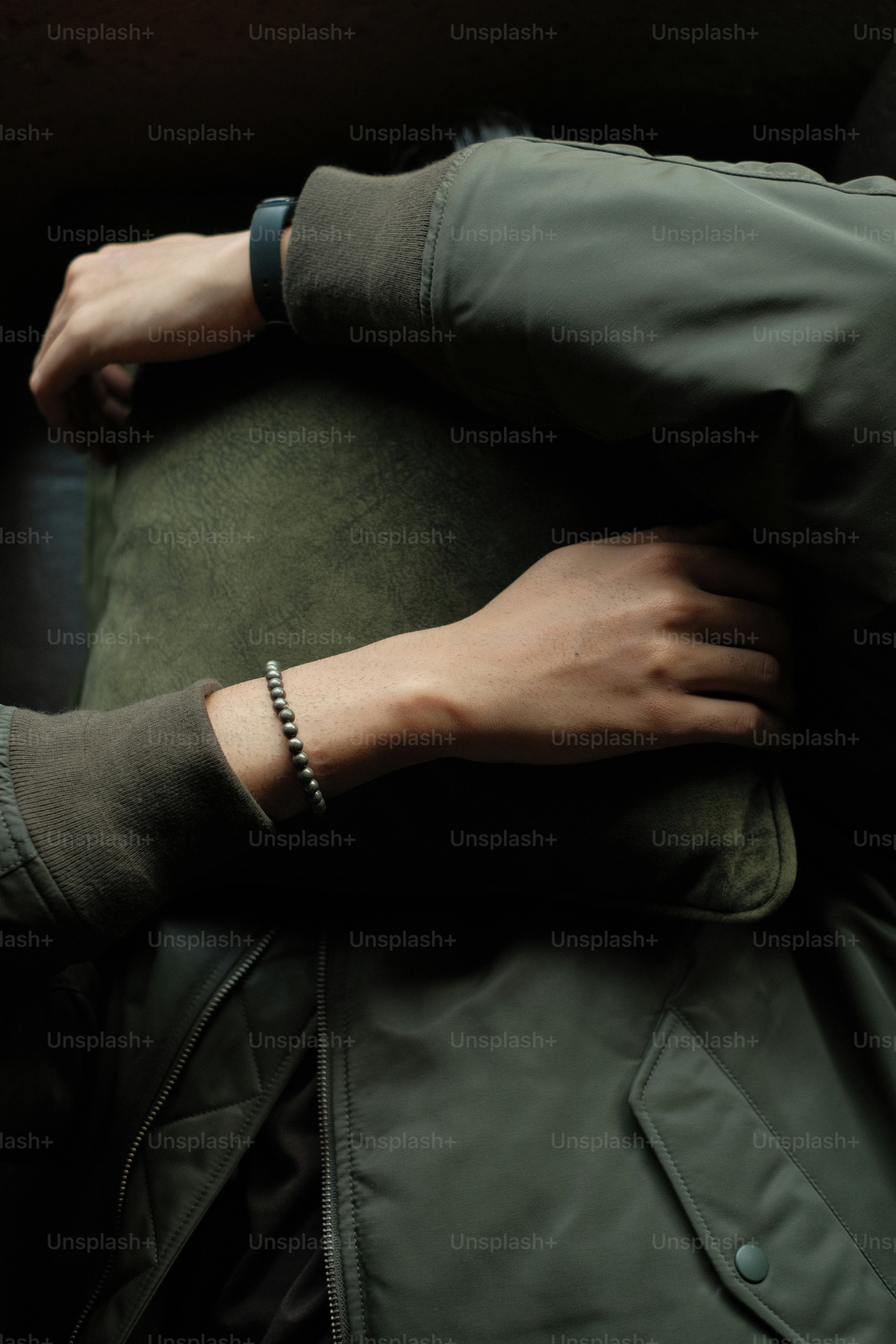 A person's arm wrapped around a pillow photo – Bracelet Image on Unsplash