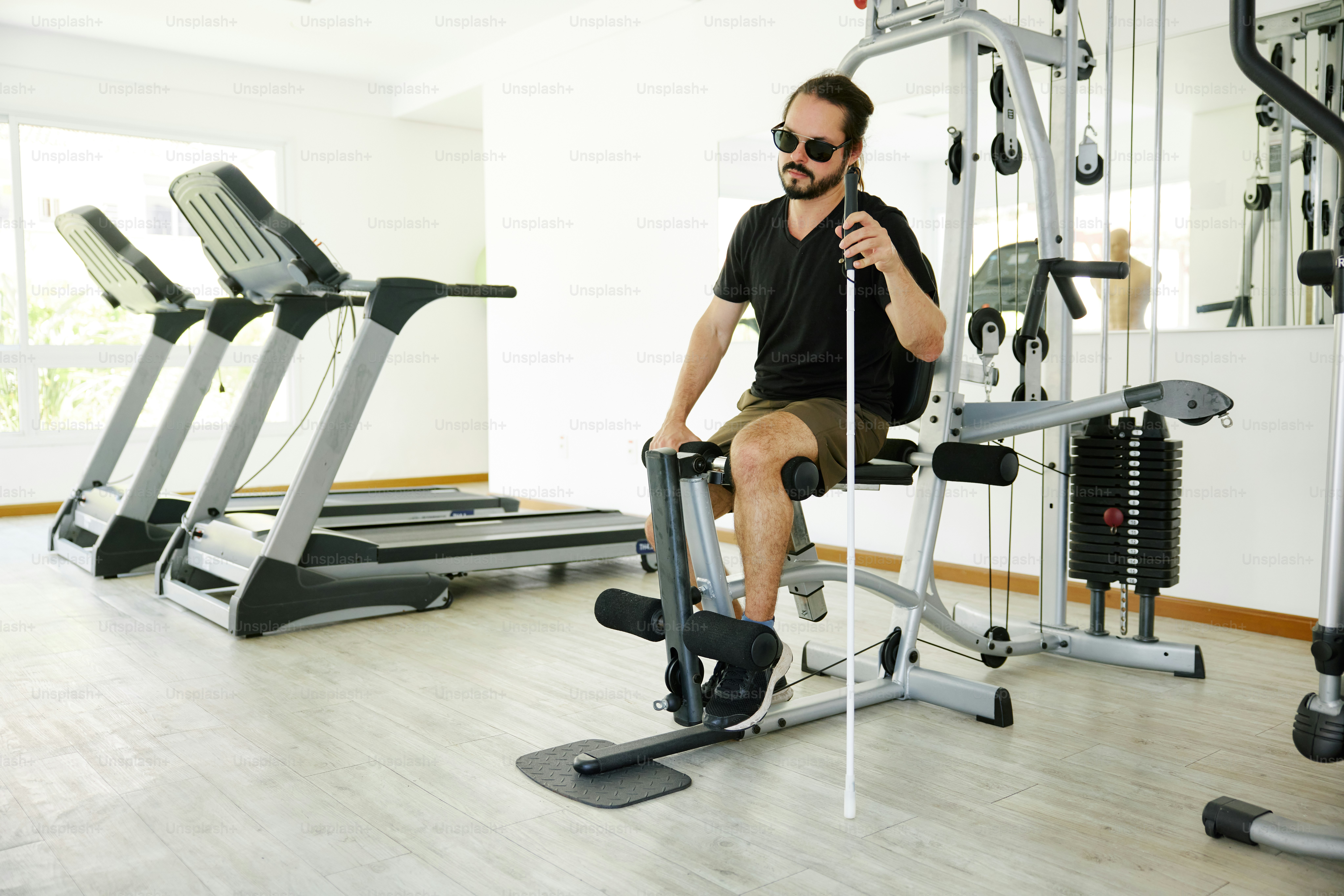 A man sitting on a machine in a gym photo – Cane Image on Unsplash
