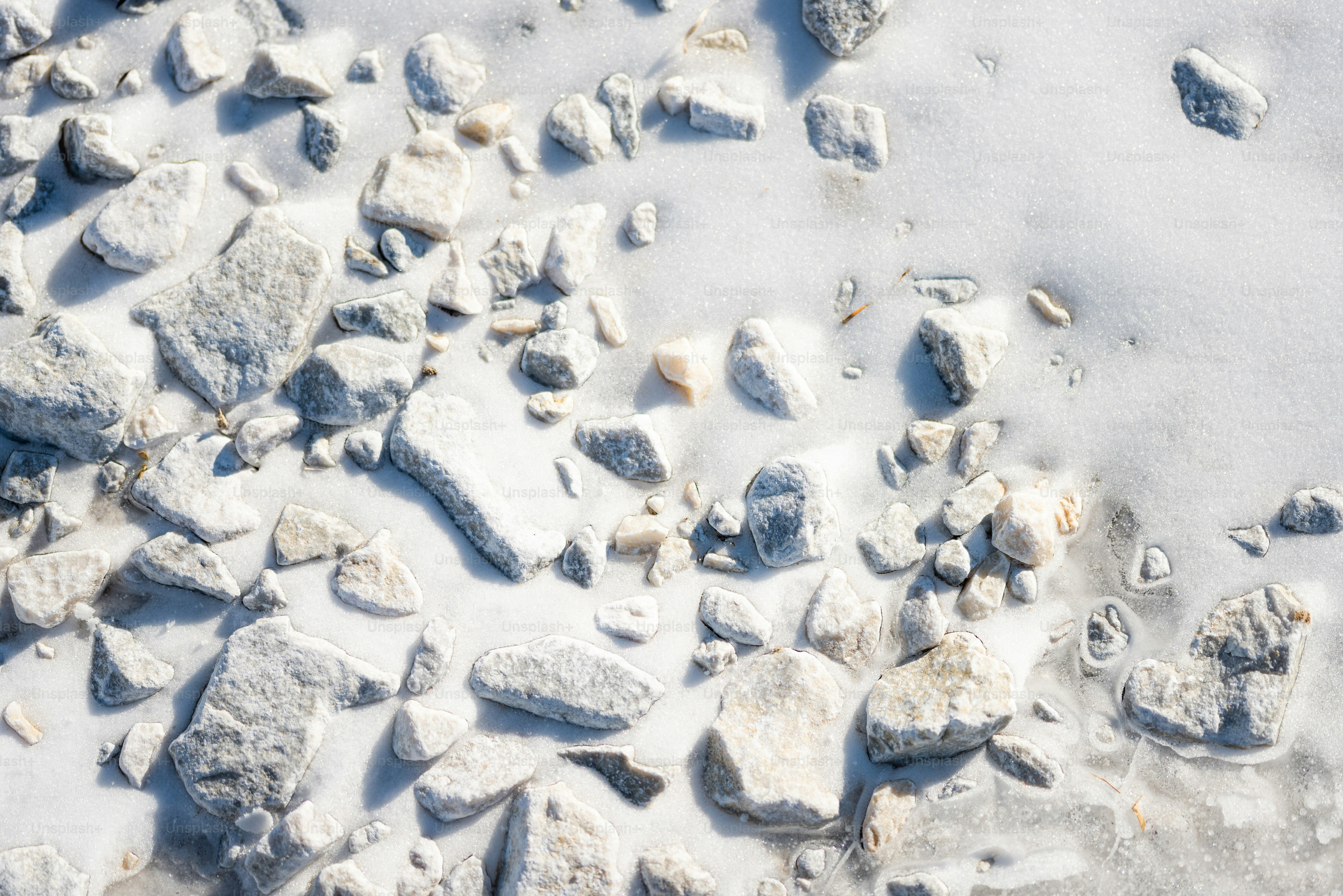 A bunch of rocks that are laying in the snow photo – Snow Image on Unsplash