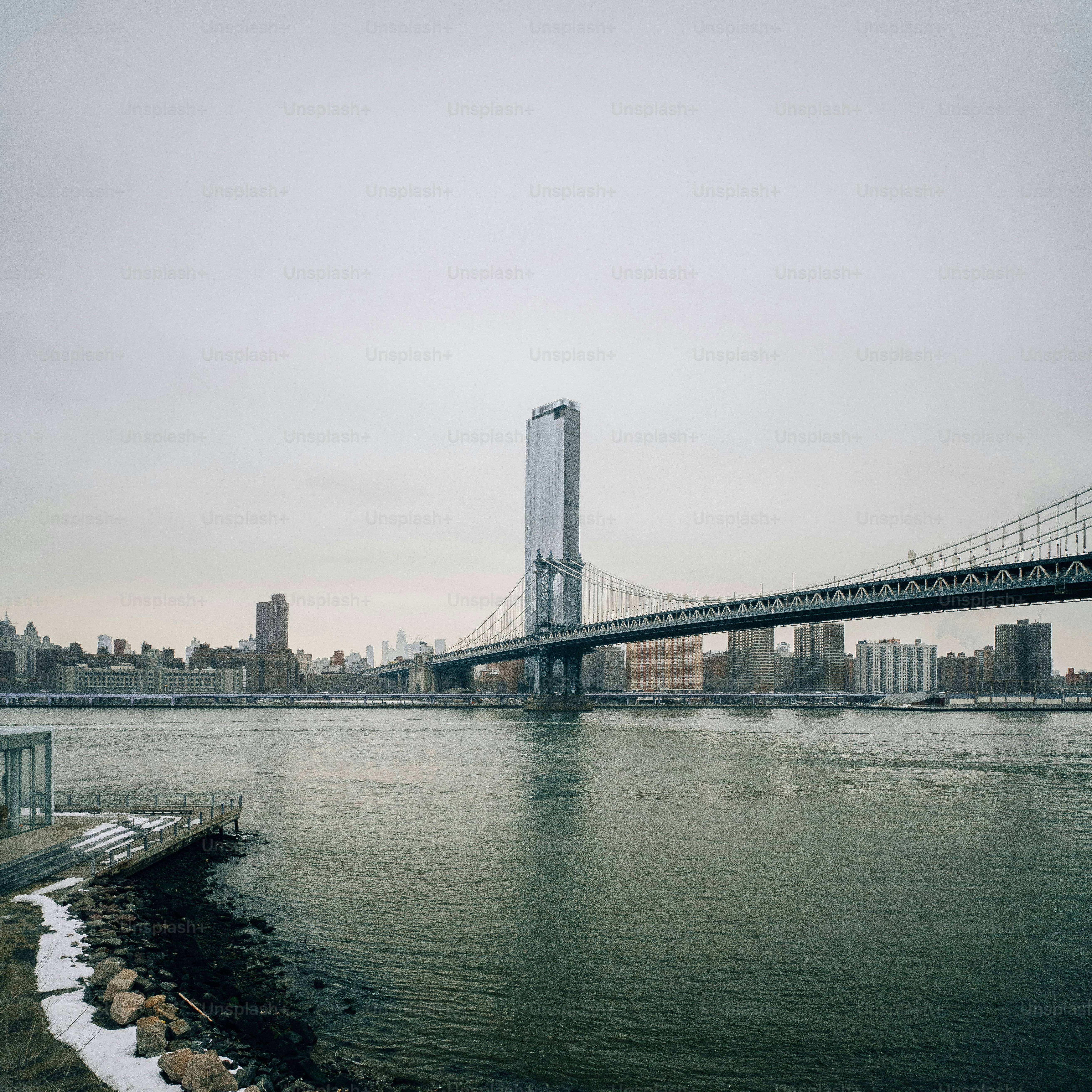 A large bridge over a large body of water photo – Manhattan bridge ...