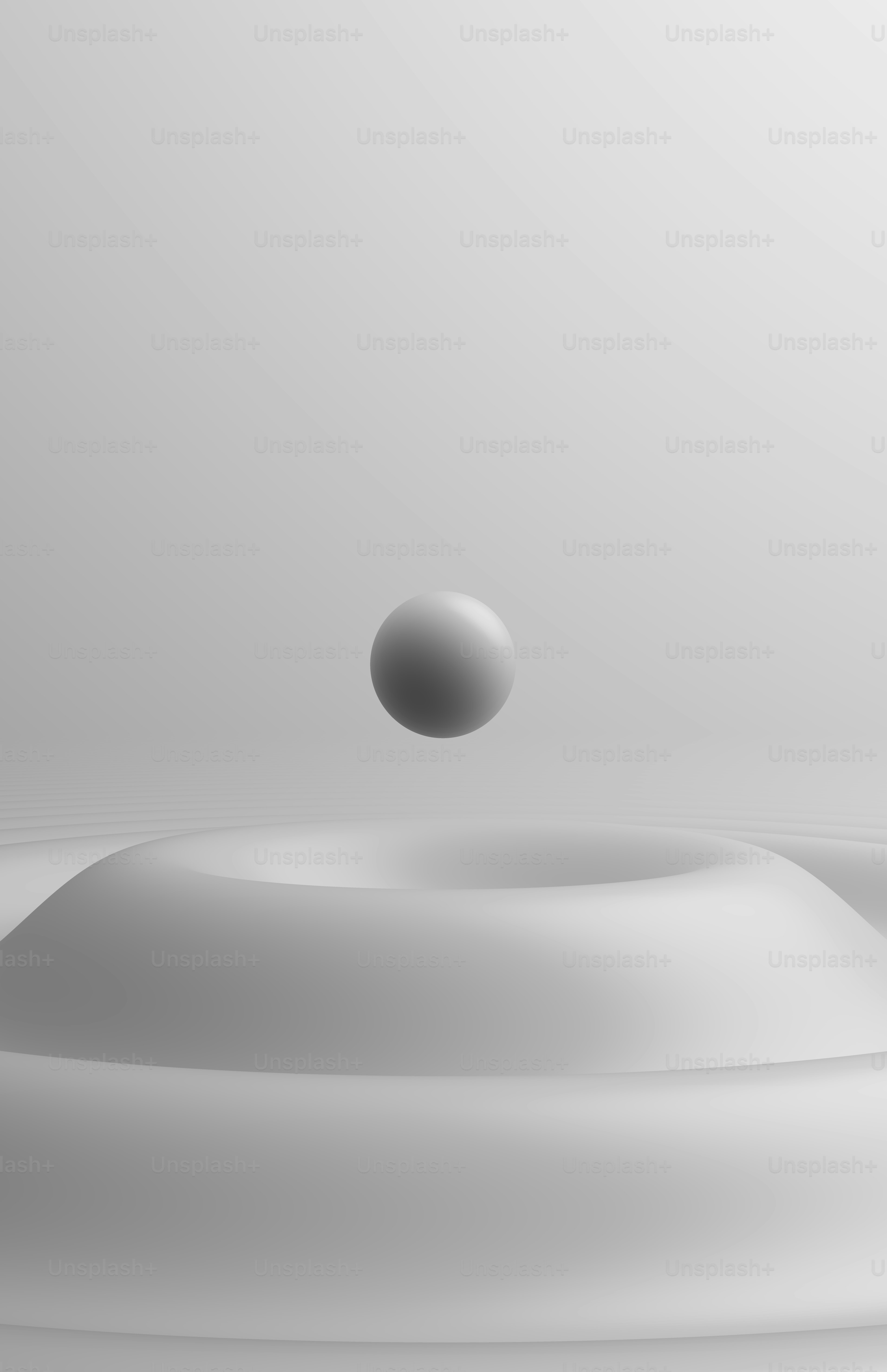 A white object floating on top of a white surface photo – Gray Image on ...