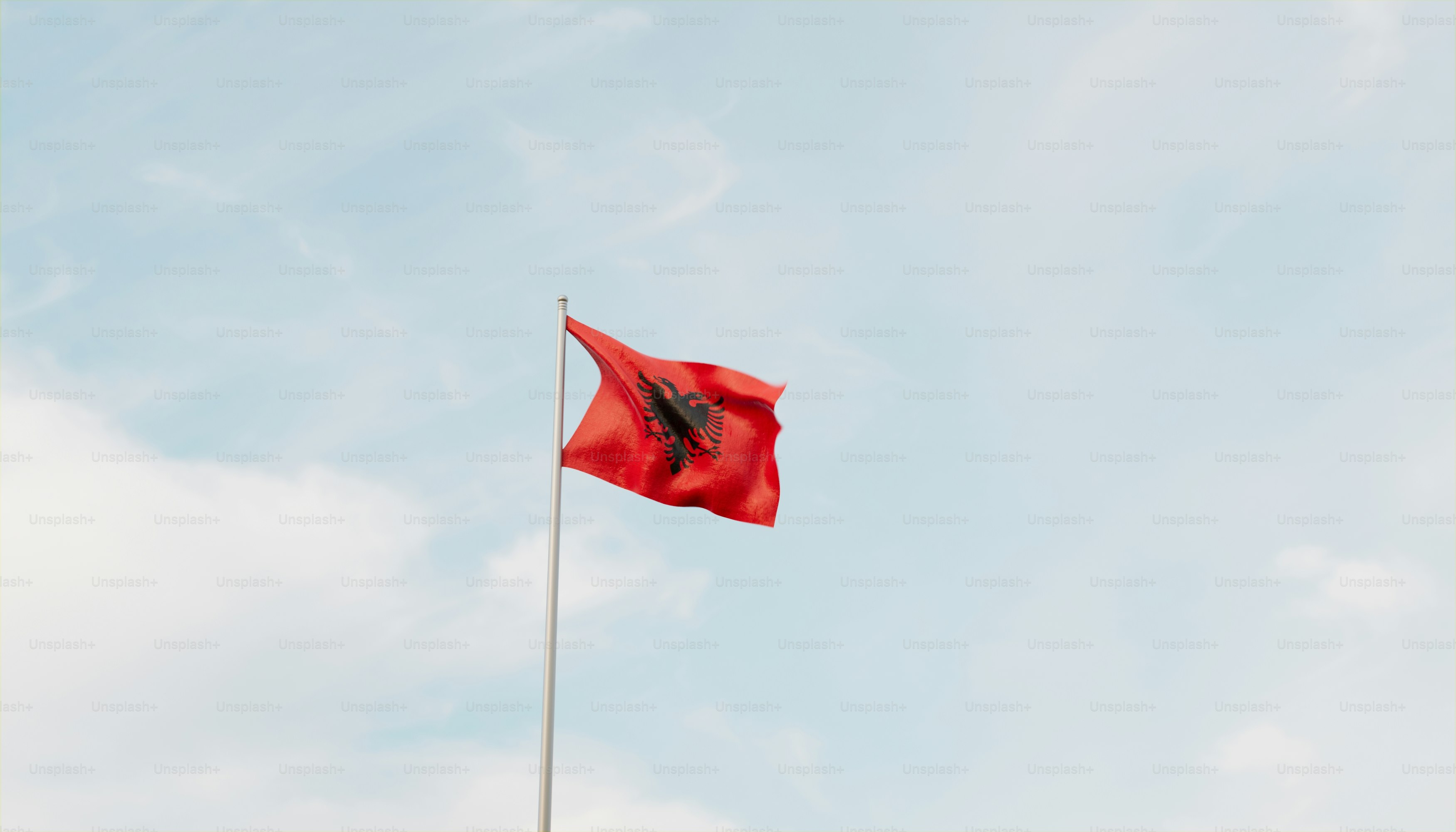 A red flag flying high in the sky photo – Albania Image on Unsplash