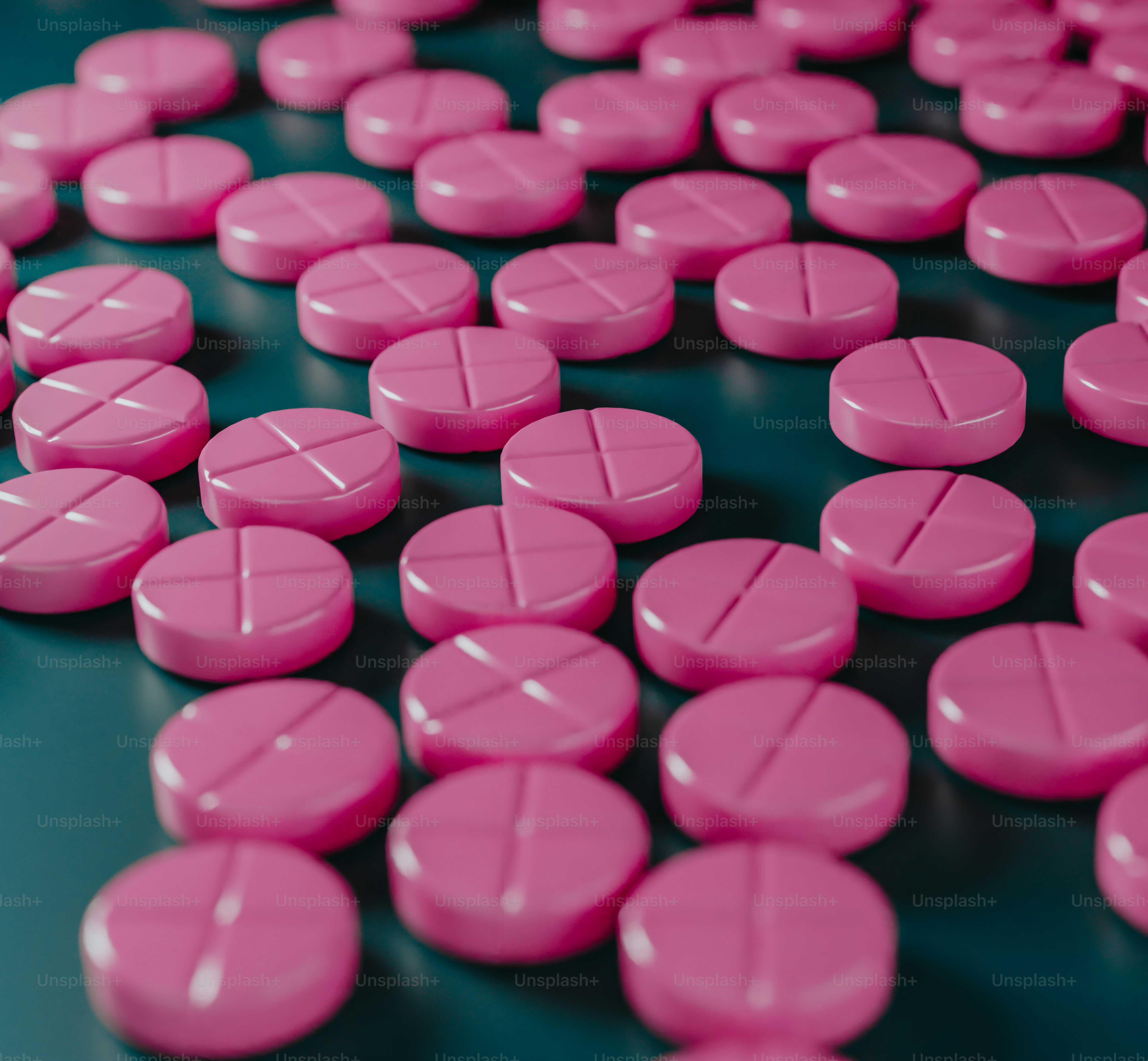 A group of pink pills sitting on top of a table photo – Medication ...