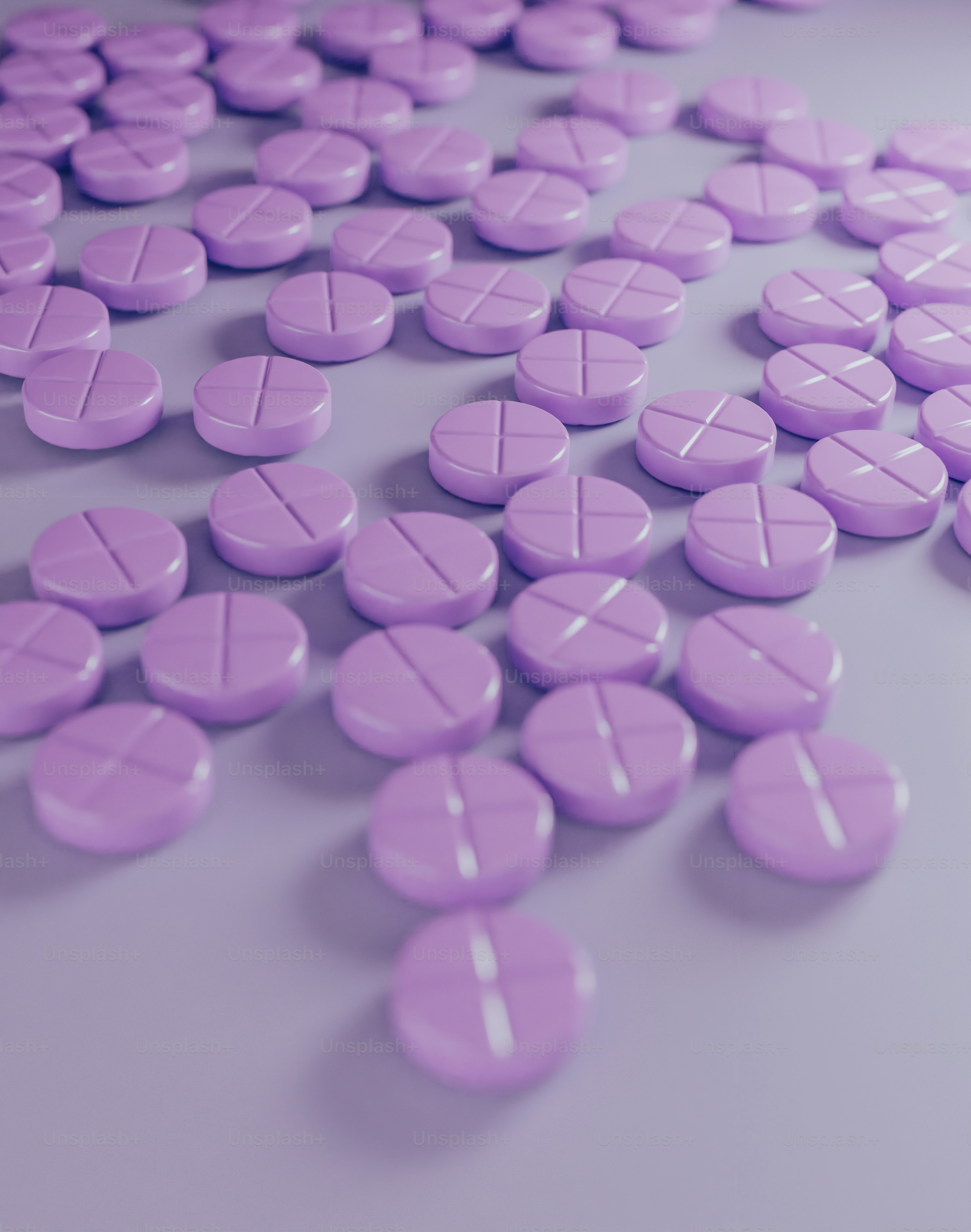 A group of purple pills sitting on top of a table photo – Medication ...
