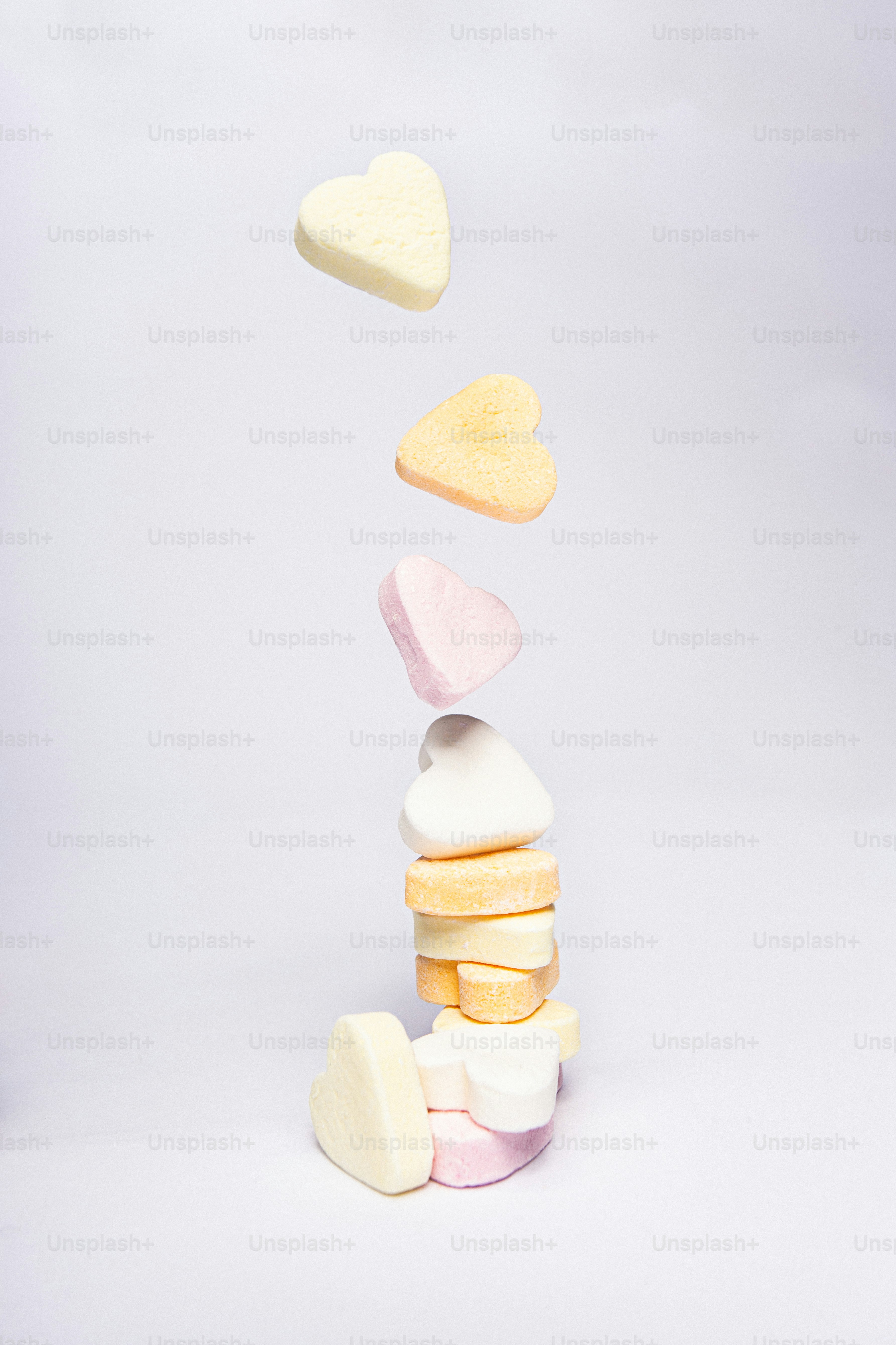 A stack of marshmallows falling into the air photo – Candy Image on ...