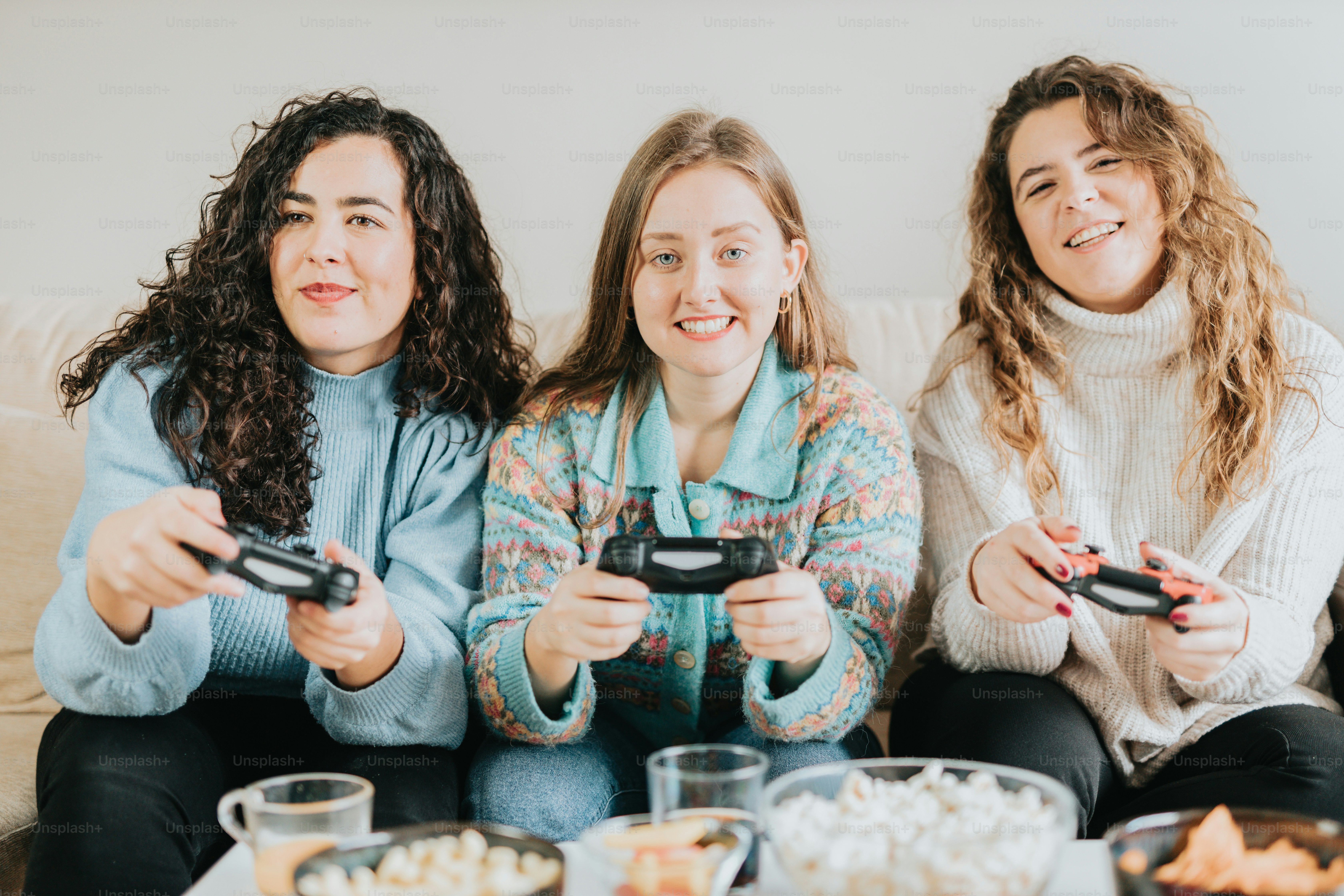 Two women are sitting on a couch and one is brushing her teeth photo ...