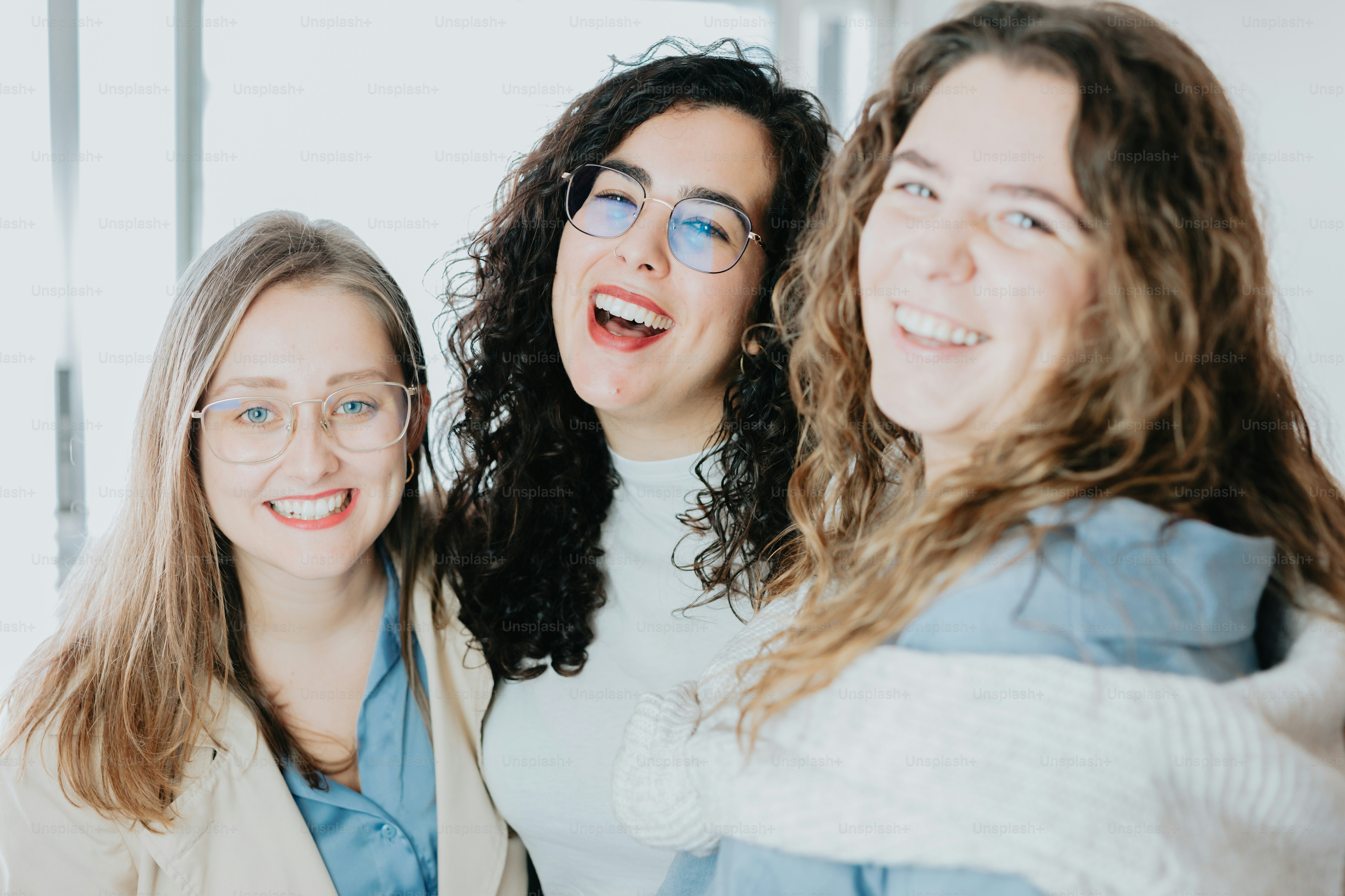A group of three women standing next to each other photo – Happy Image ...