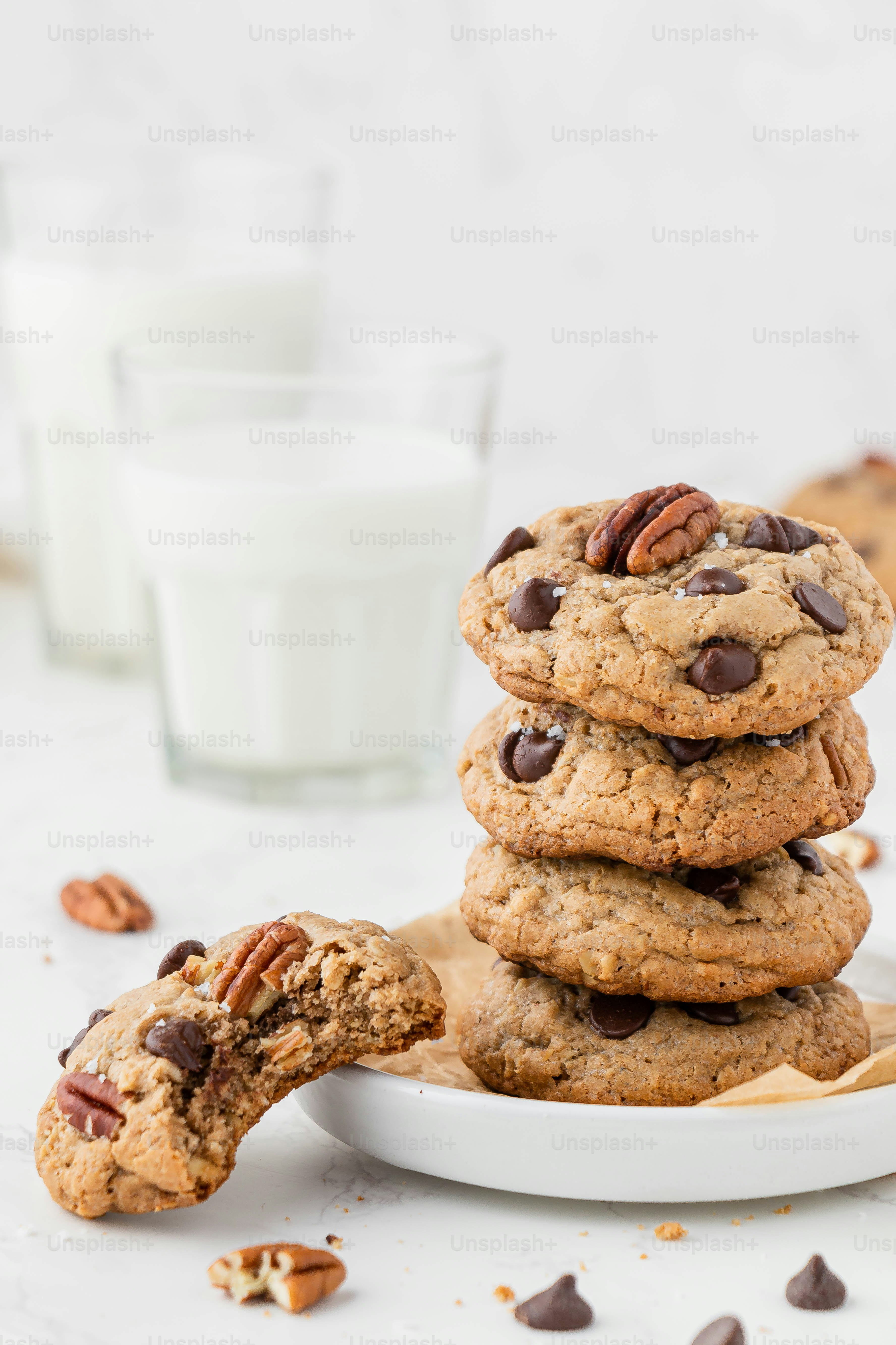 A stack of cookies sitting on top of a white plate photo – Chocolate ...