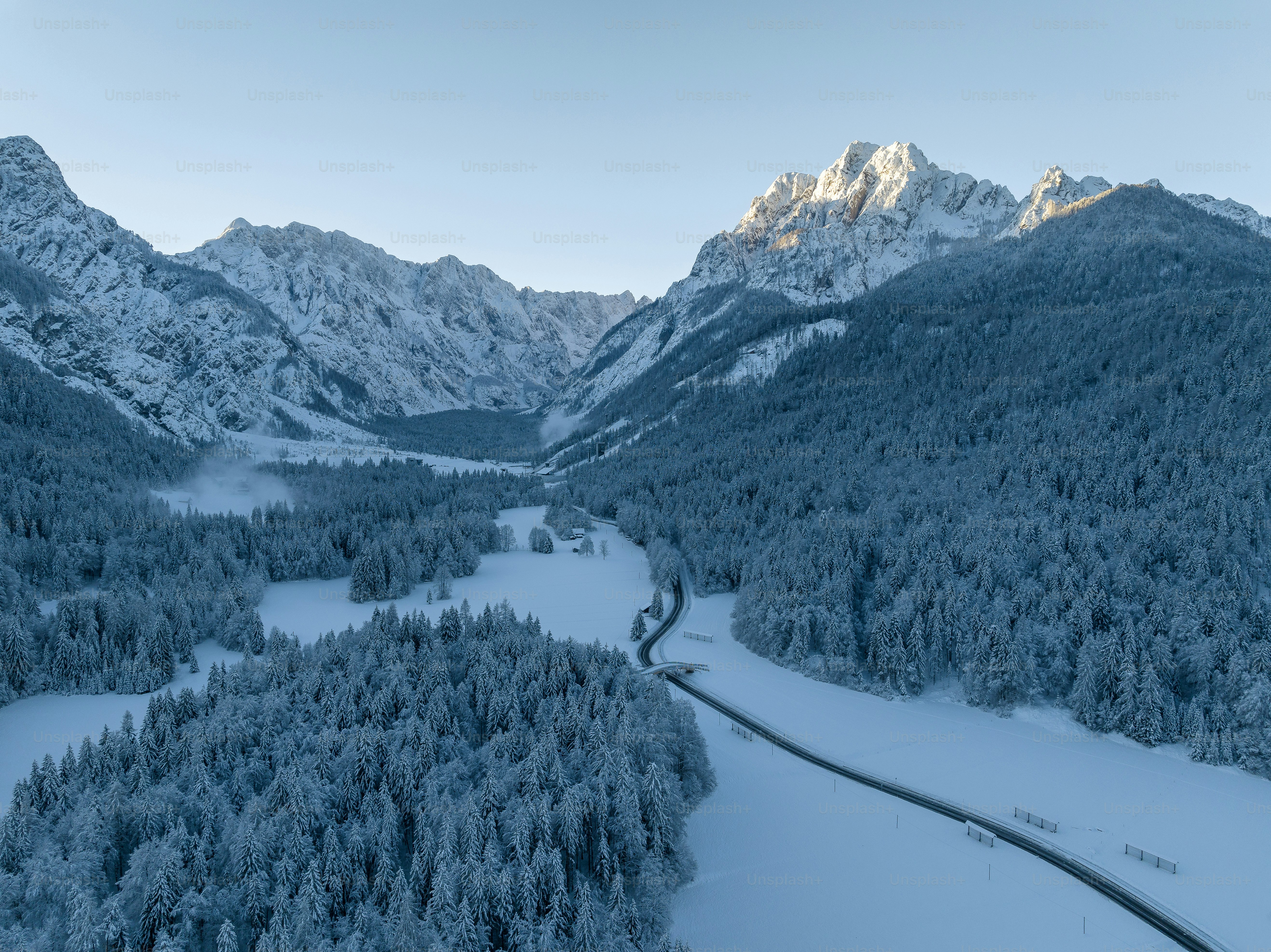 An aerial view of a snowy mountain valley photo – Scenery Image on Unsplash