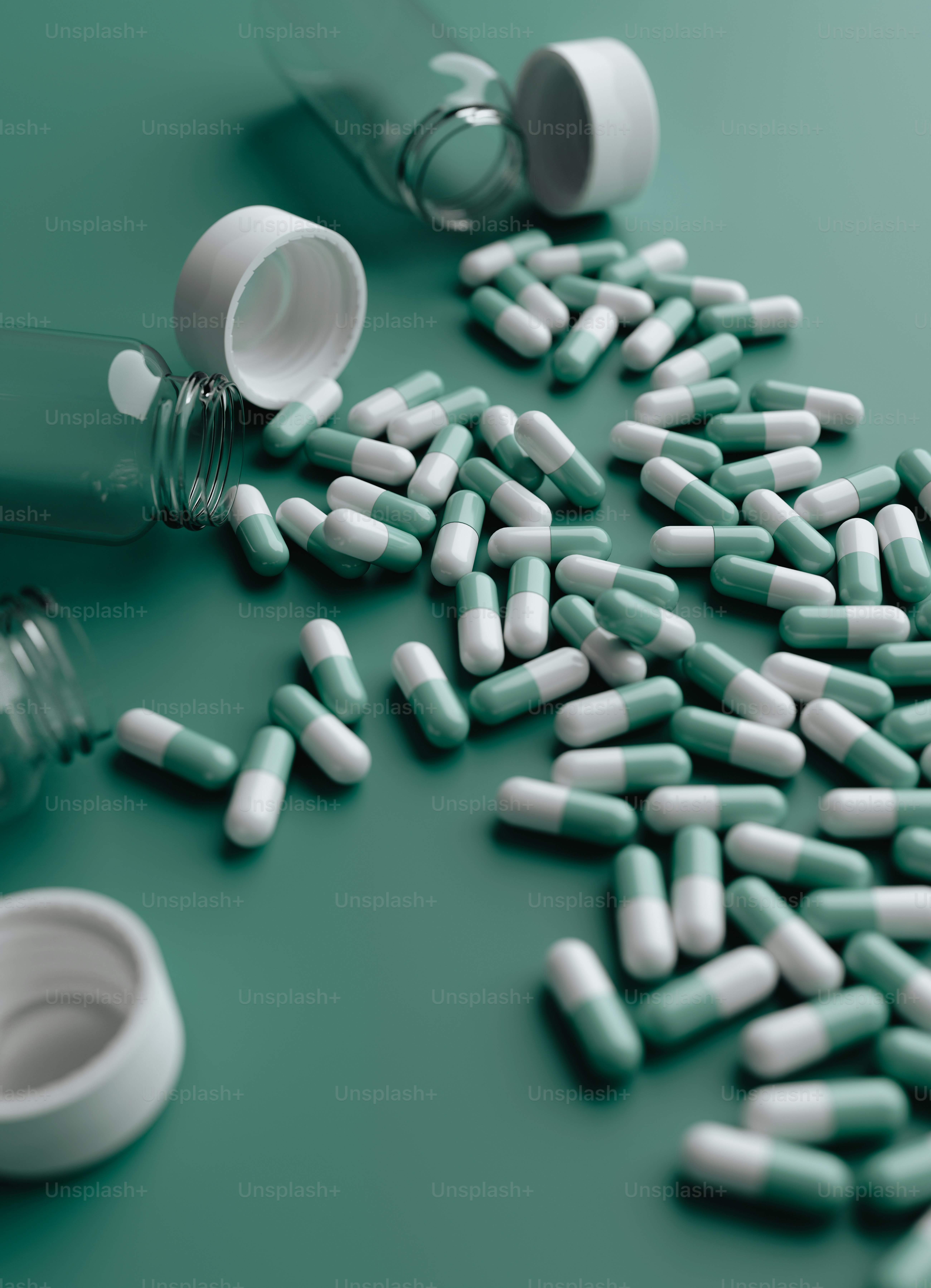 Pills spilling out of a bottle onto a table photo – Medication Image on ...