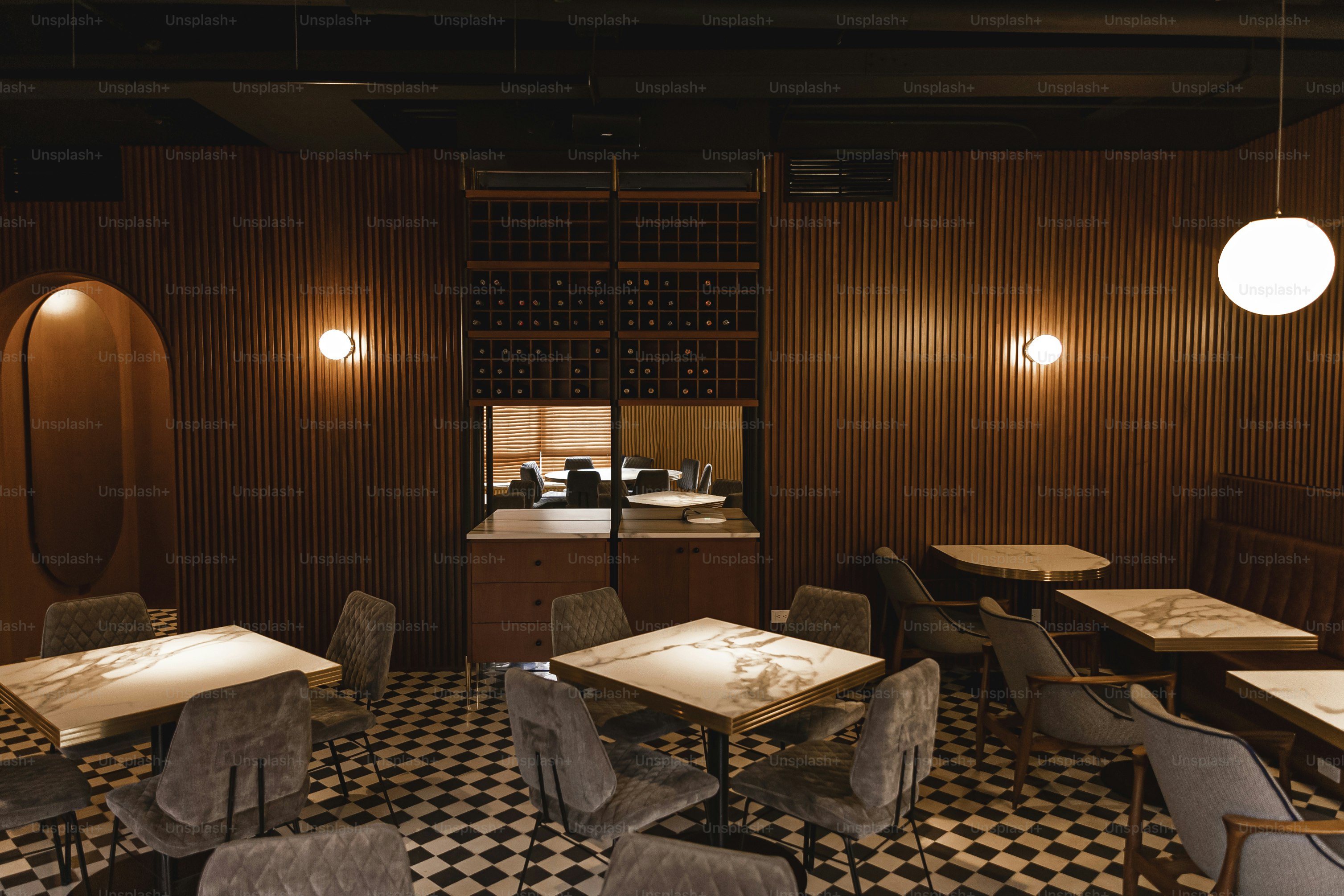 A restaurant with a checkered floor and wooden walls photo – Interior ...