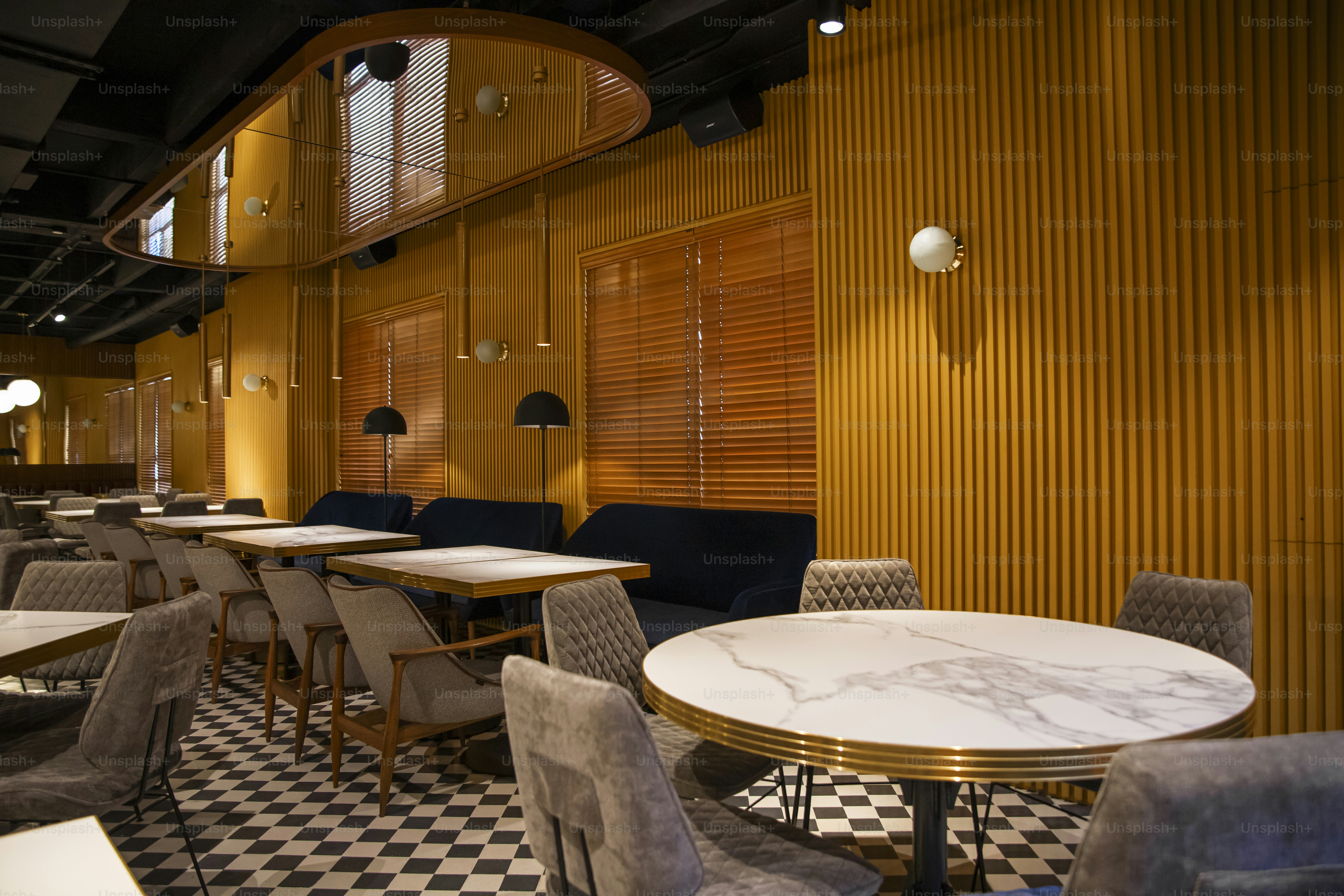 A restaurant with a checkered floor and wooden walls photo – Interior ...