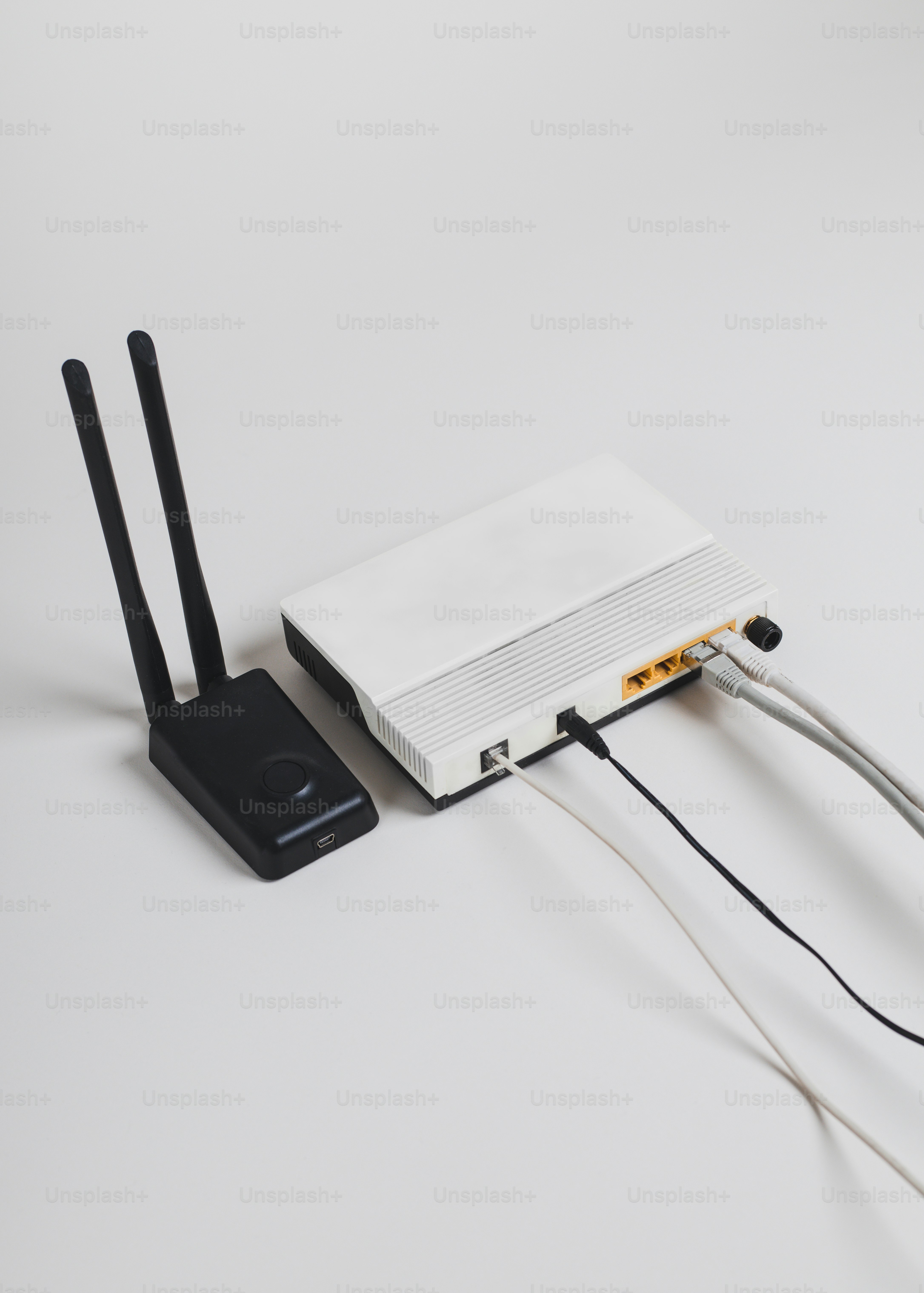 A router connected to a router on a white surface photo – Network Image ...