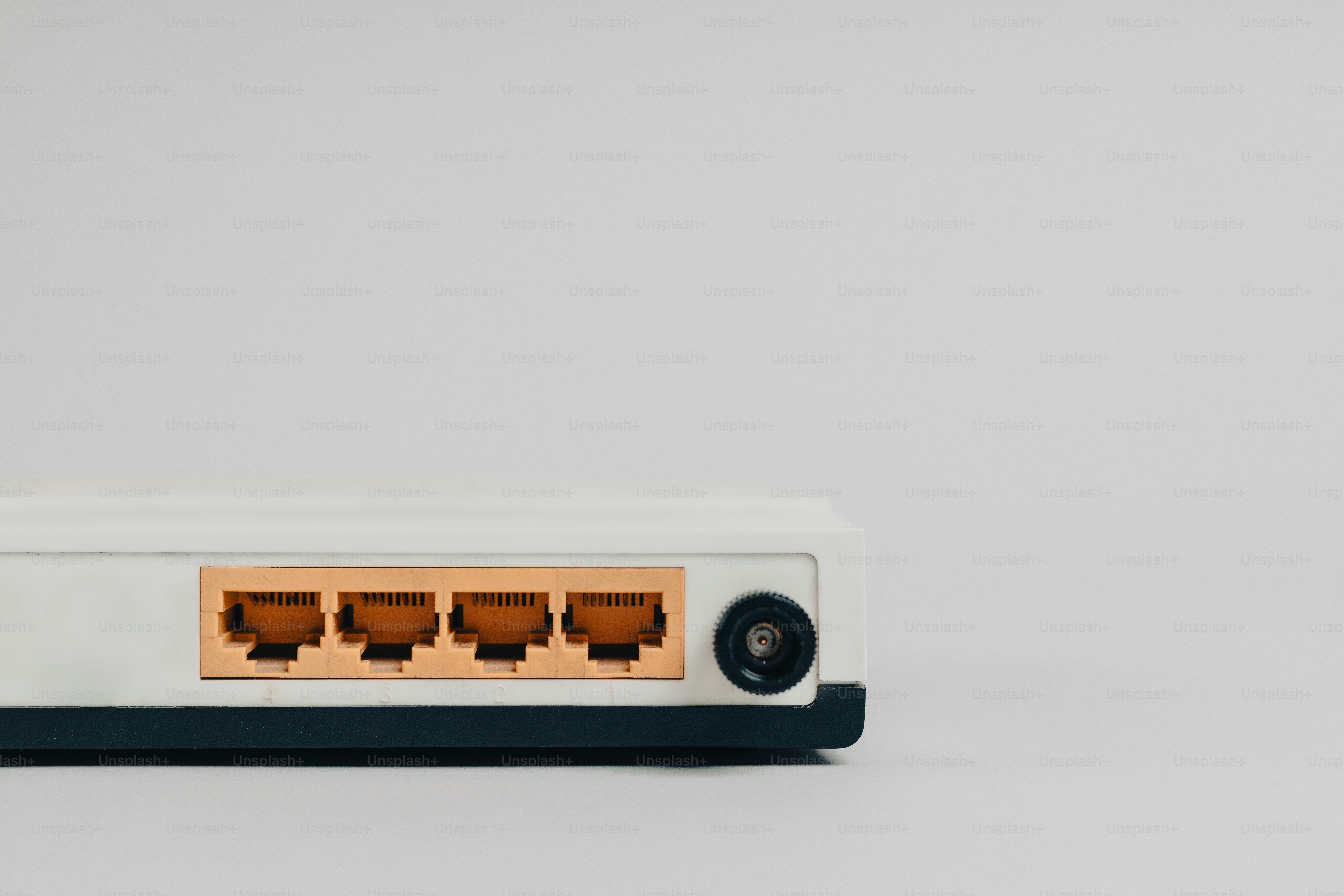 A close up of a router on a white surface photo – Modem Image on Unsplash