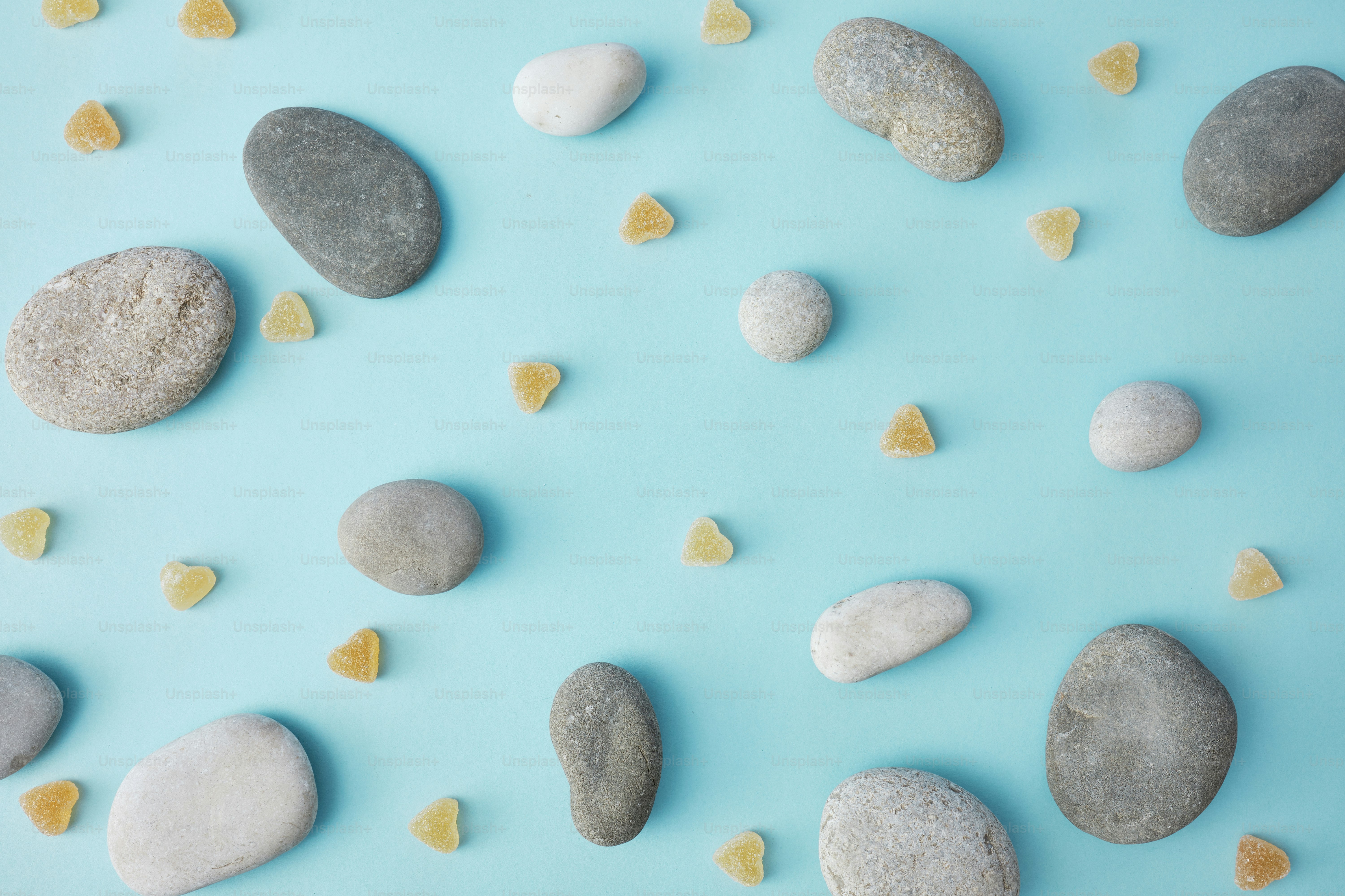 A group of three rocks sitting on top of a table photo – Background ...