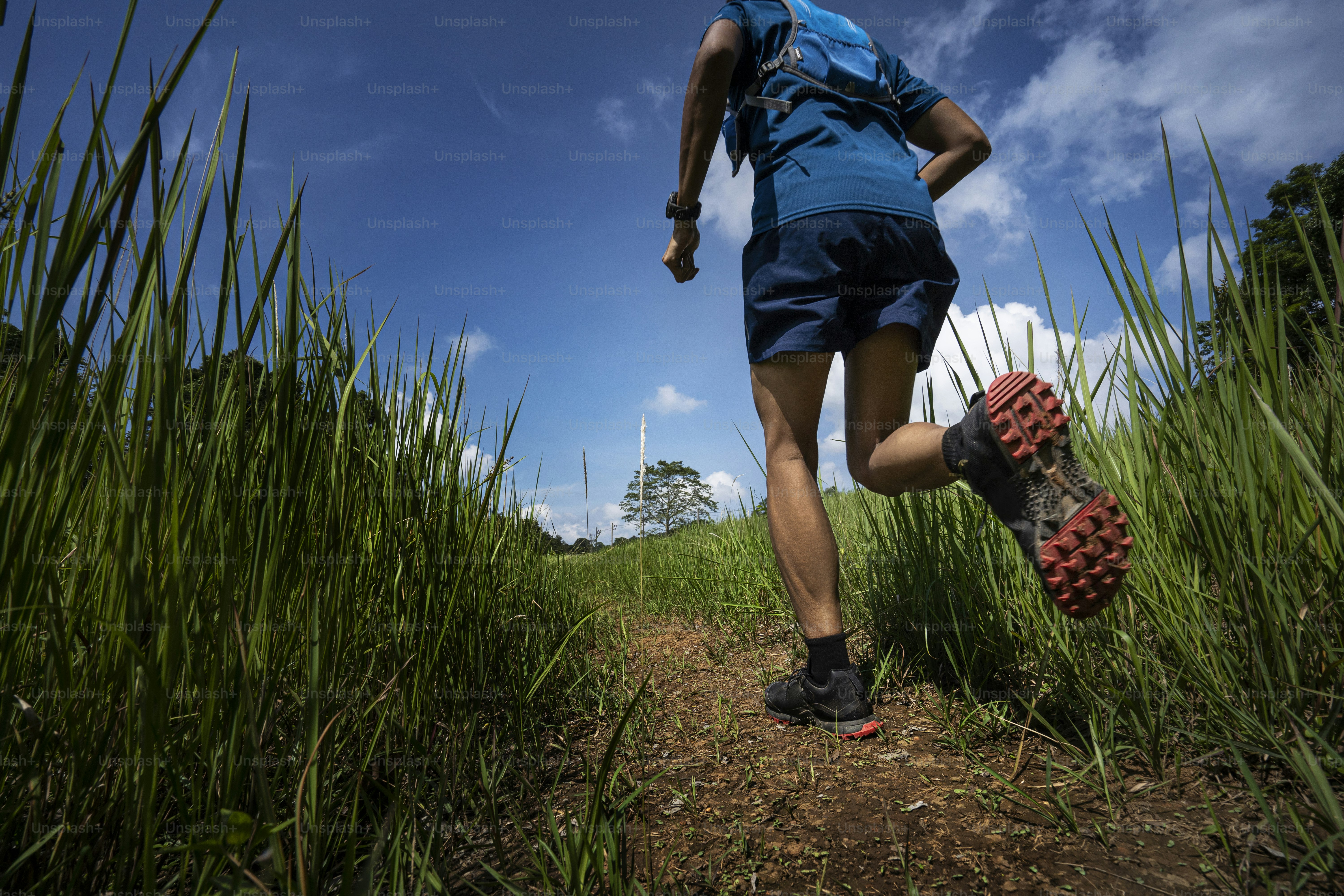 Asian men are running a trail In the natural path photo – Asia Image on ...