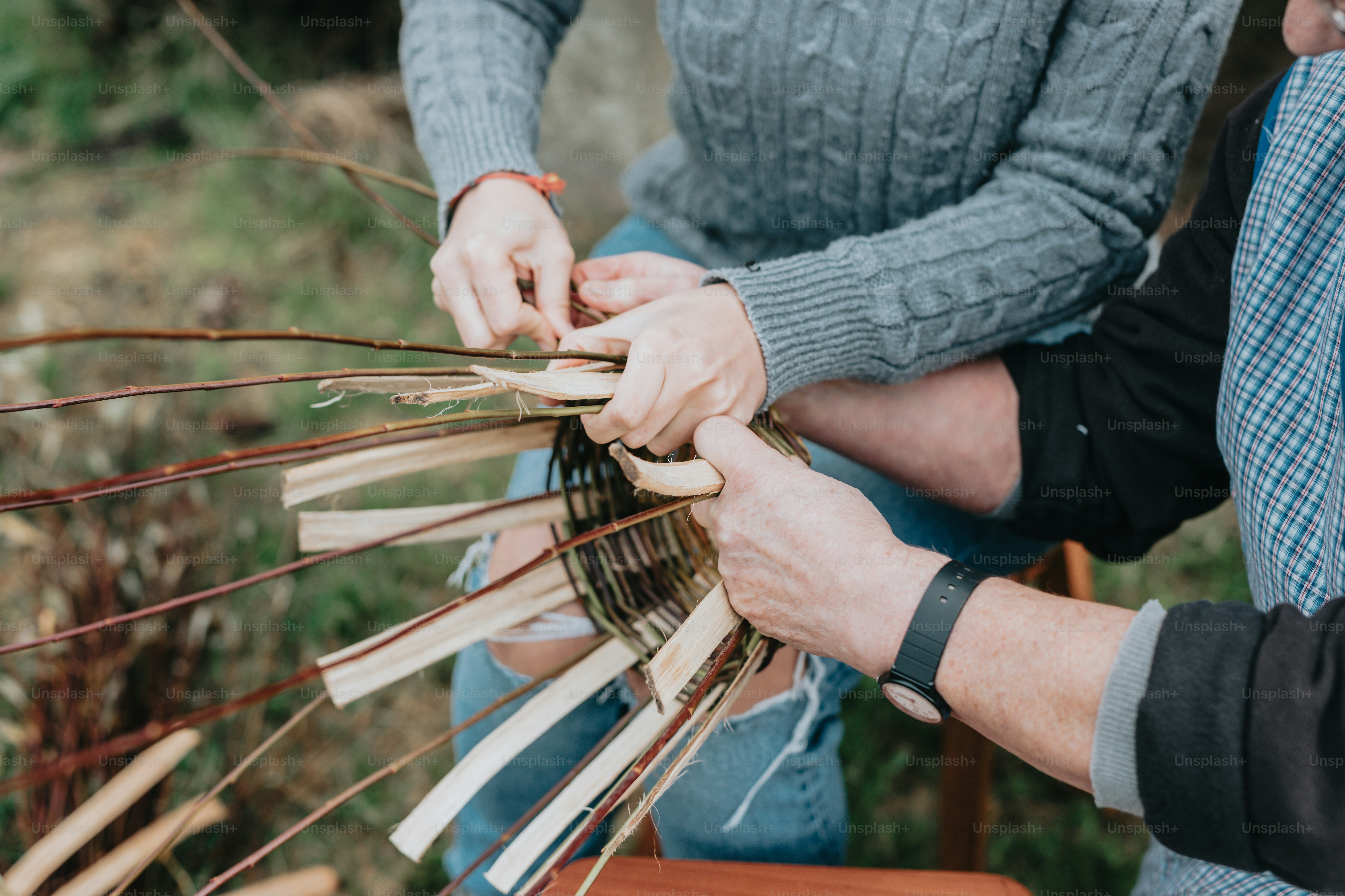 A couple of people that are holding some sticks photo – Elders Image on ...