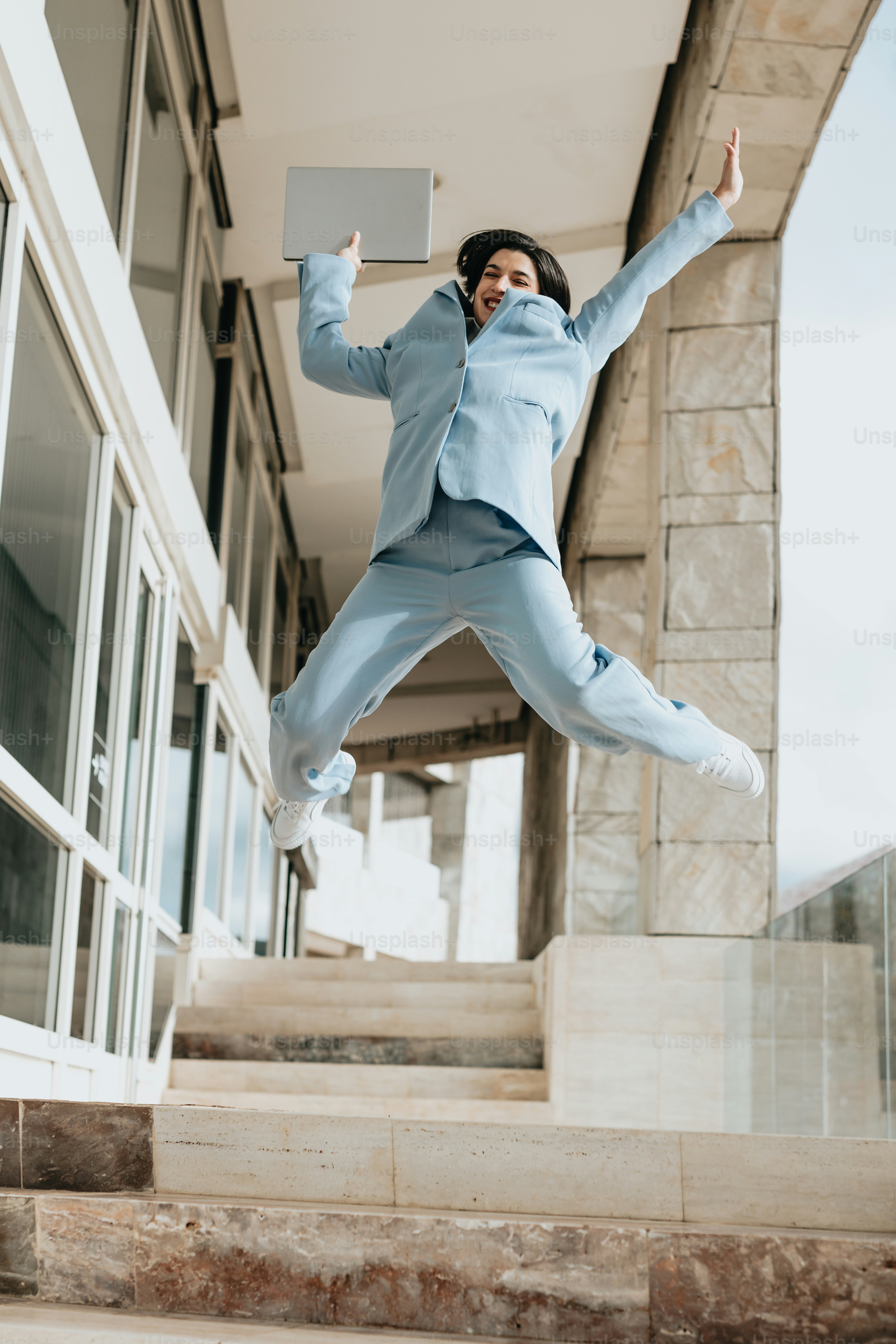 A man in a blue suit jumping in the air photo – Business Image on Unsplash