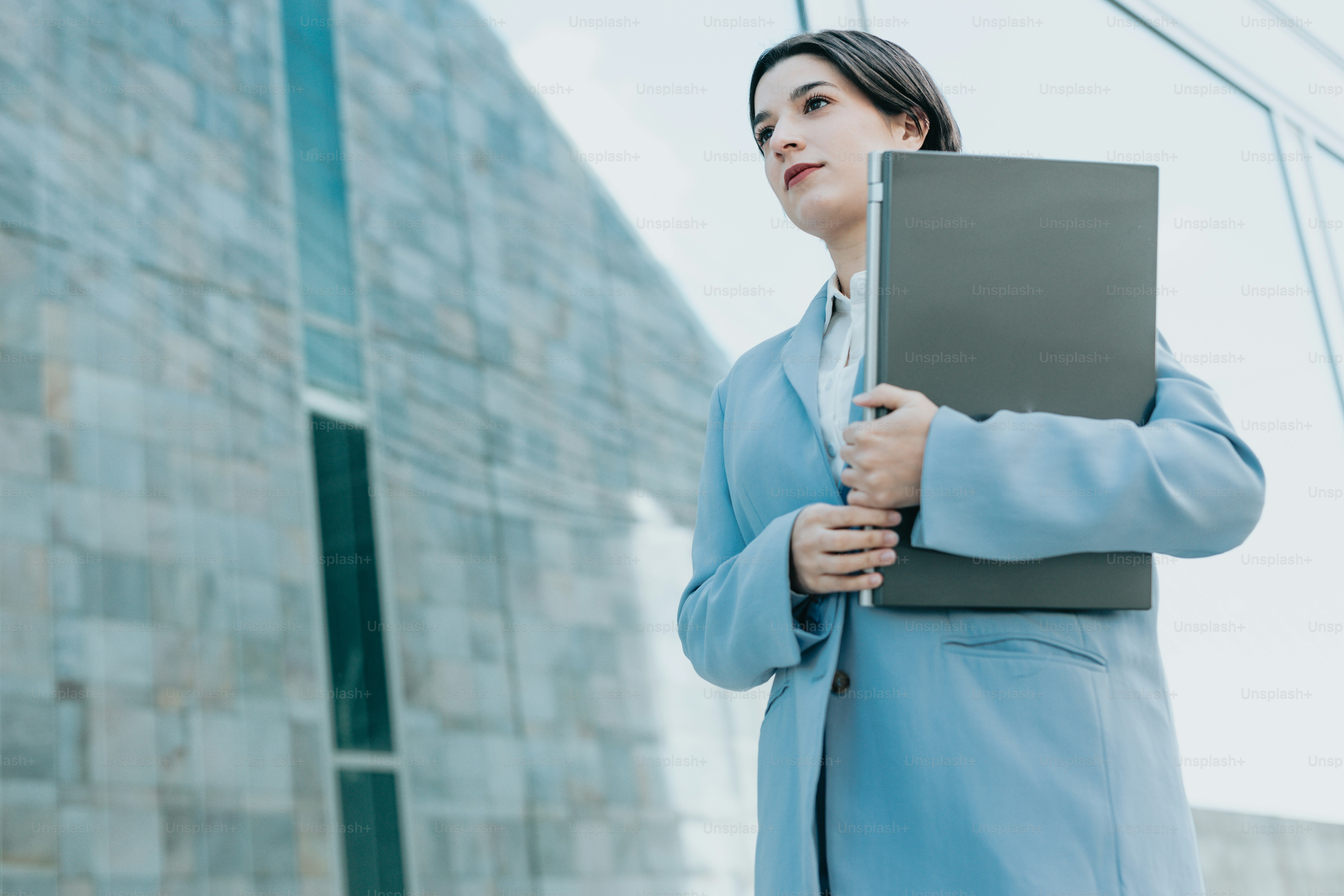 A woman in a business suit holding a binder photo – Women Image on Unsplash