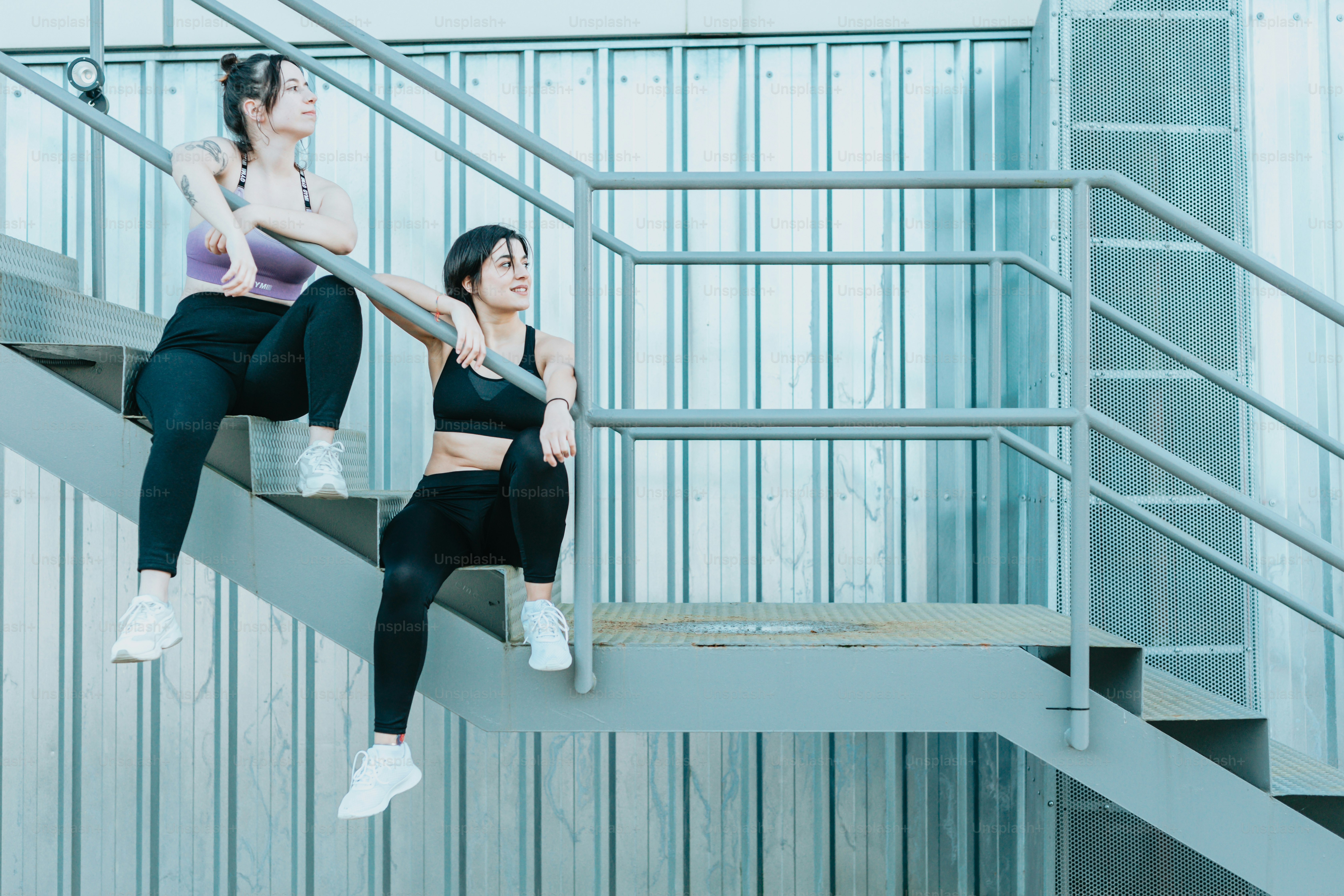 Two women are sitting on the stairs of a building photo – Exercise ...