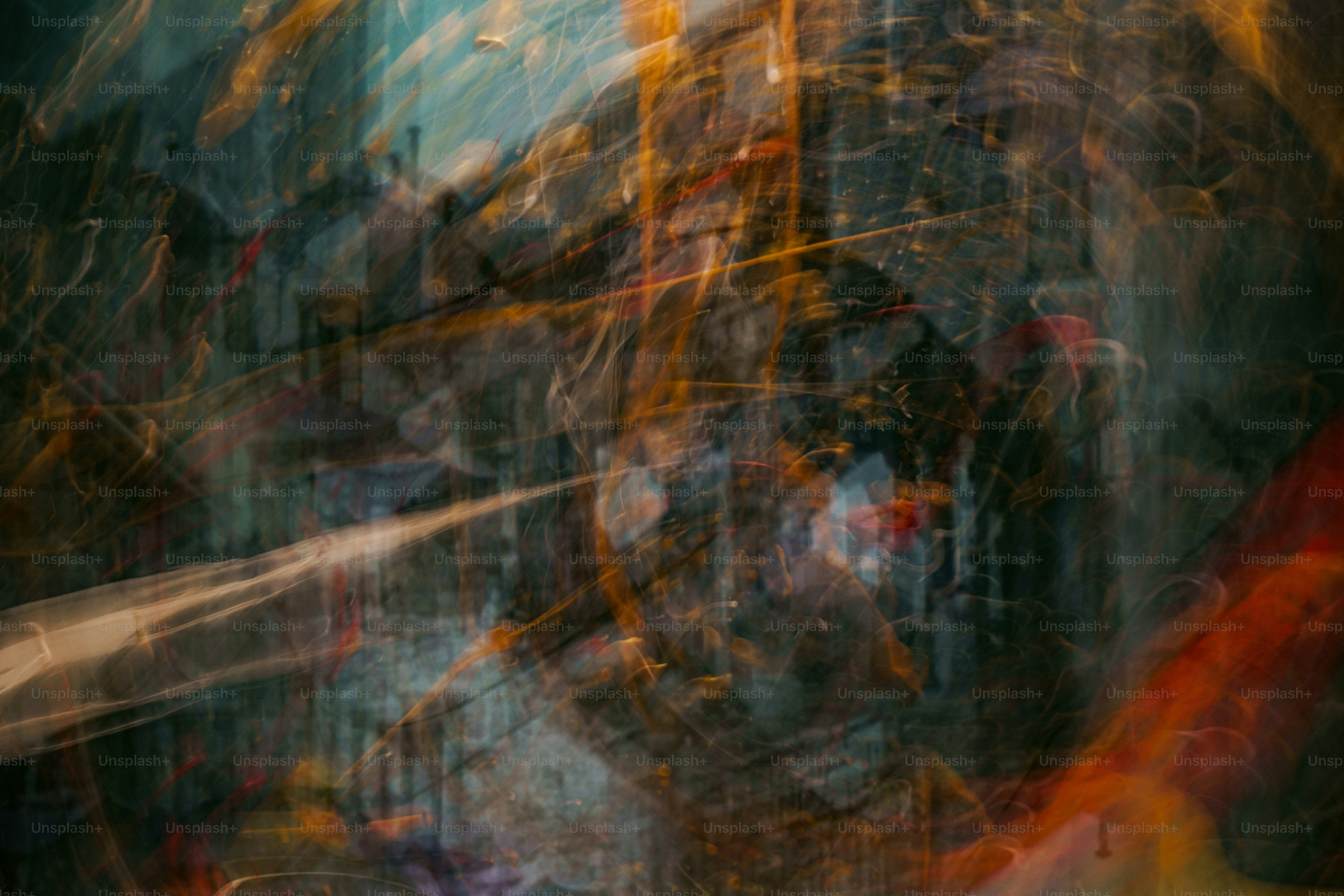 A blurry photo of a clock with a red and yellow clock face photo ...