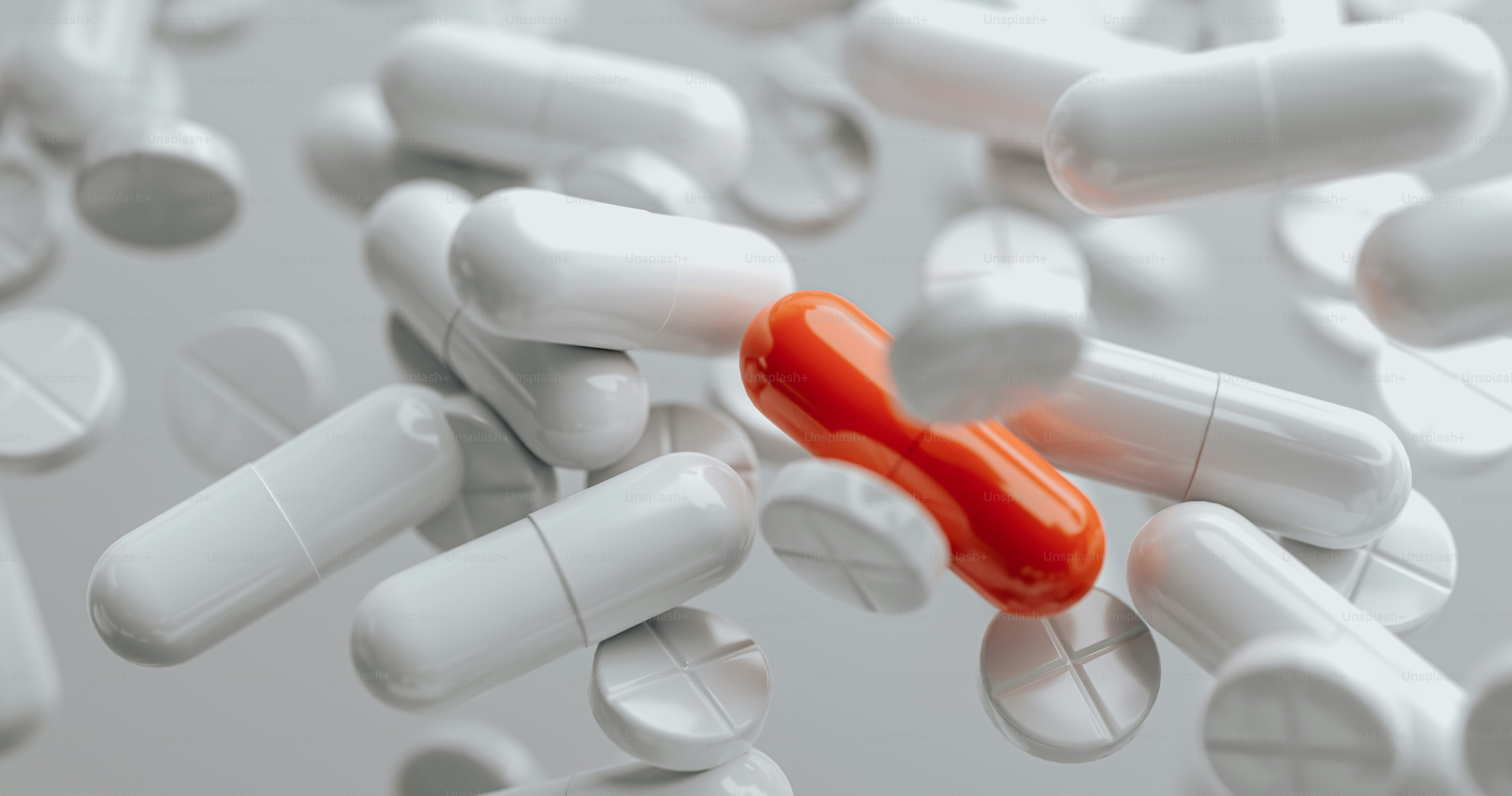 A group of pills with a red pill in the middle of them photo ...