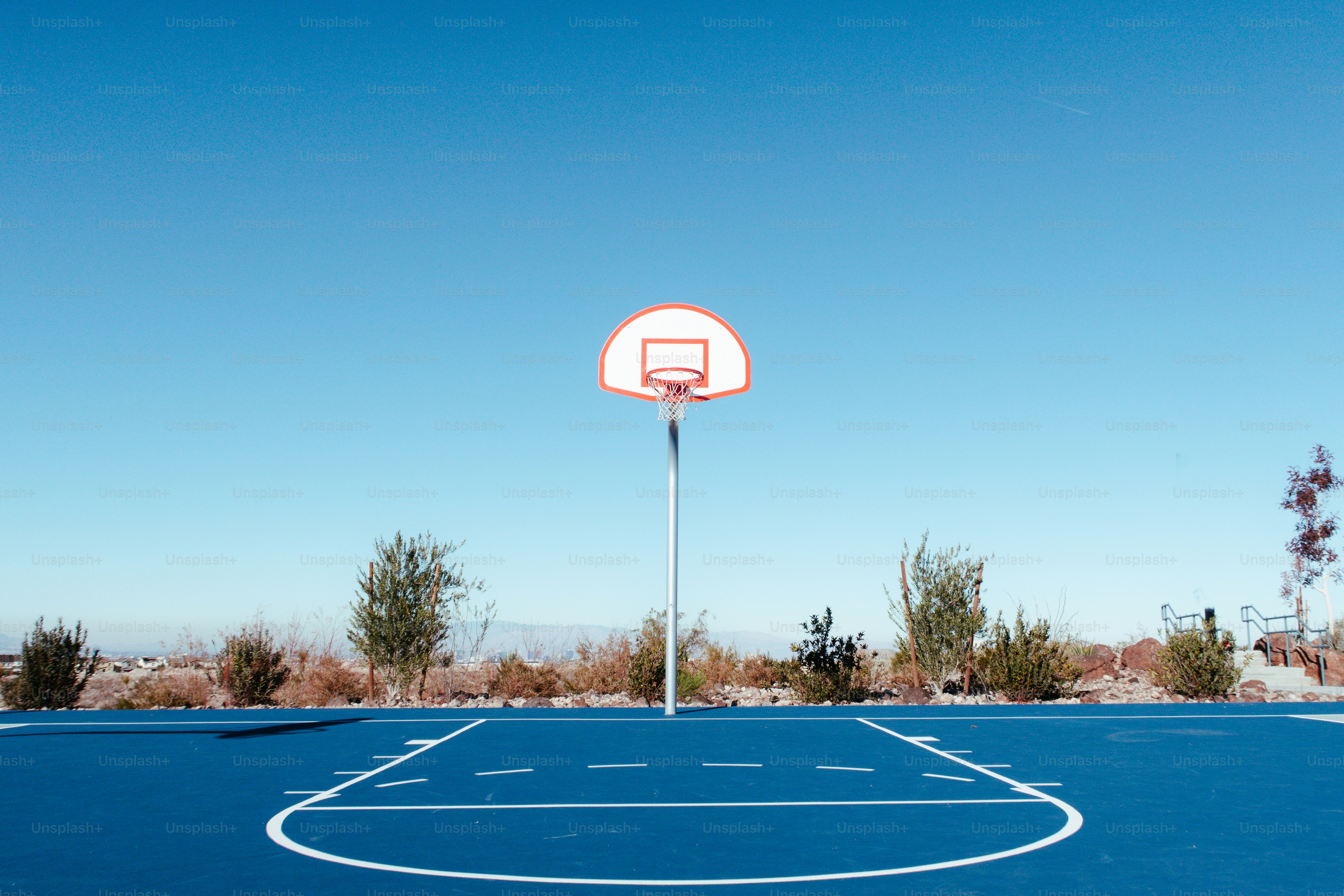 A basketball court with a basketball hoop in the middle of it photo ...