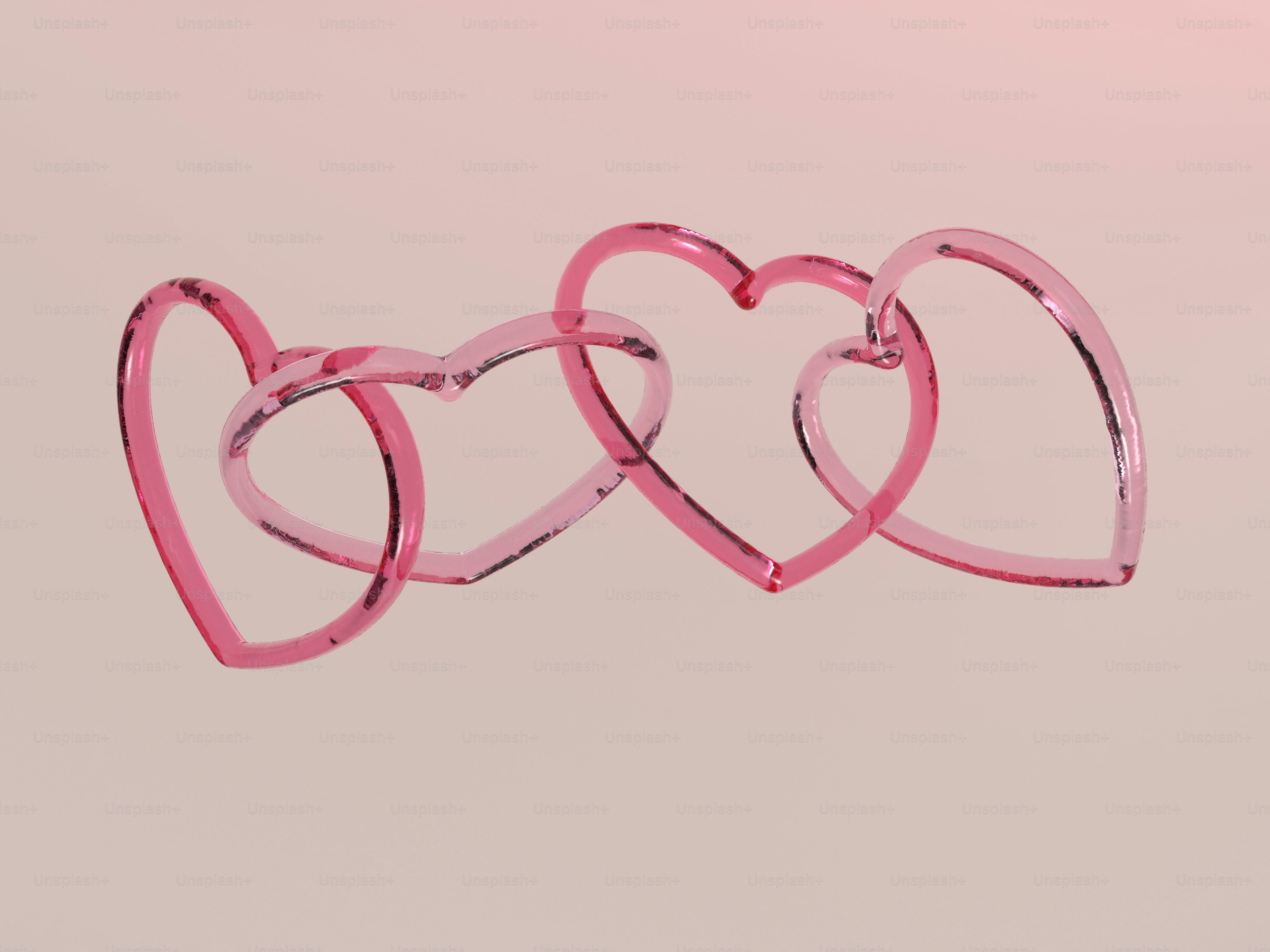 A couple of pink hearts hanging from a string photo – Wallpaper Image ...