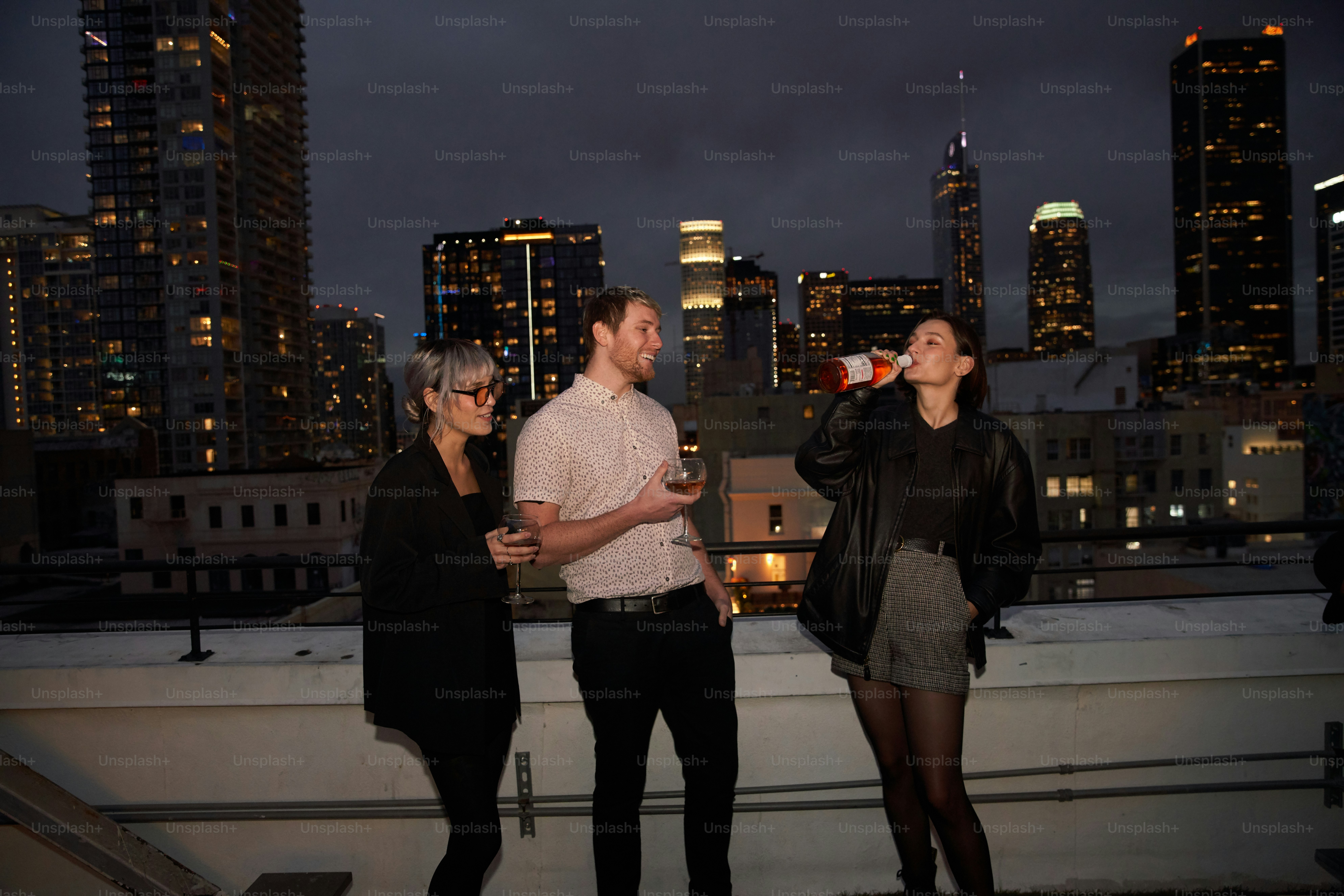 A group of people standing on top of a roof photo – Friends Image on ...