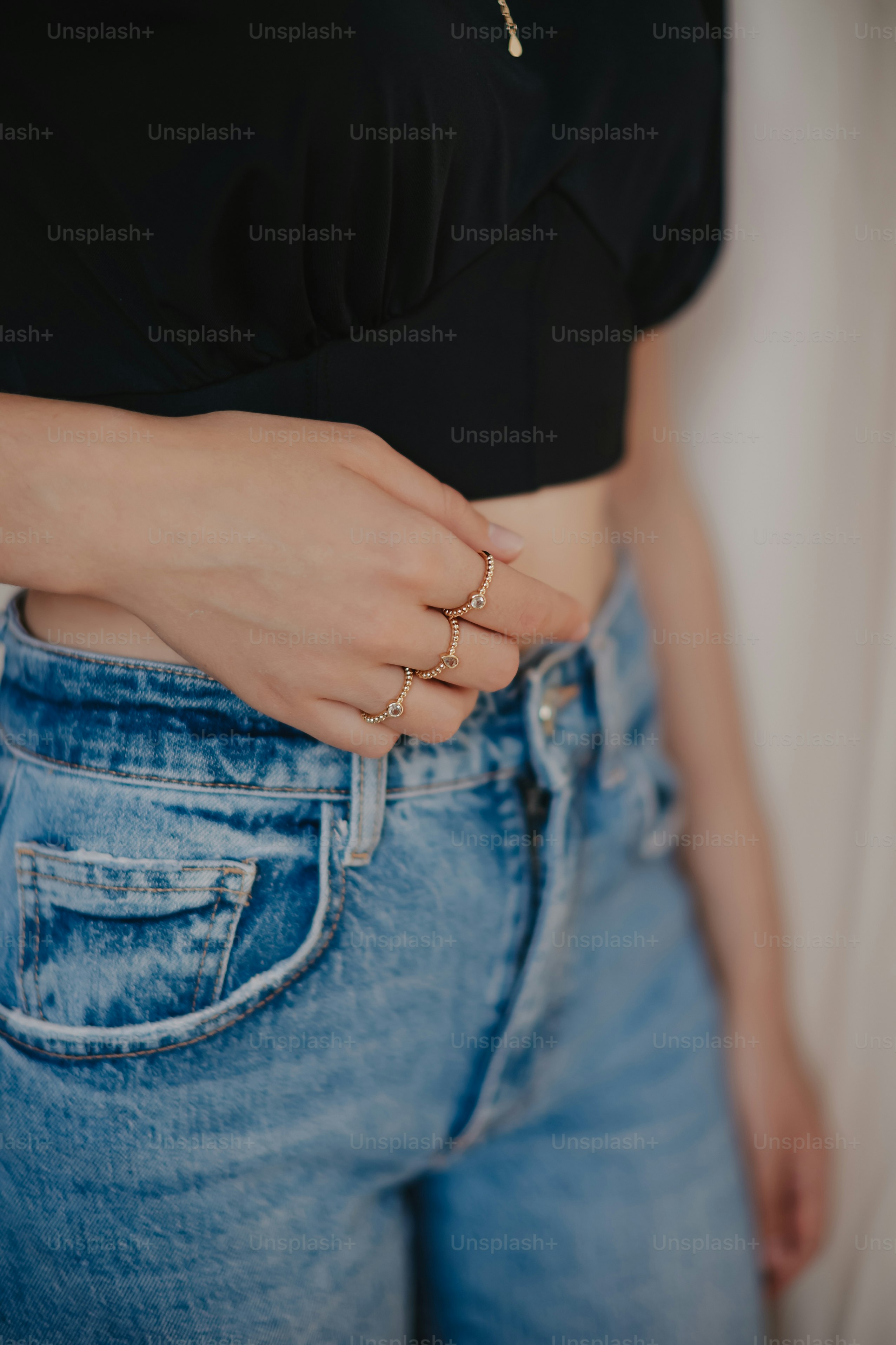 A woman's hand resting on a pair of jeans photo – Style Image on Unsplash
