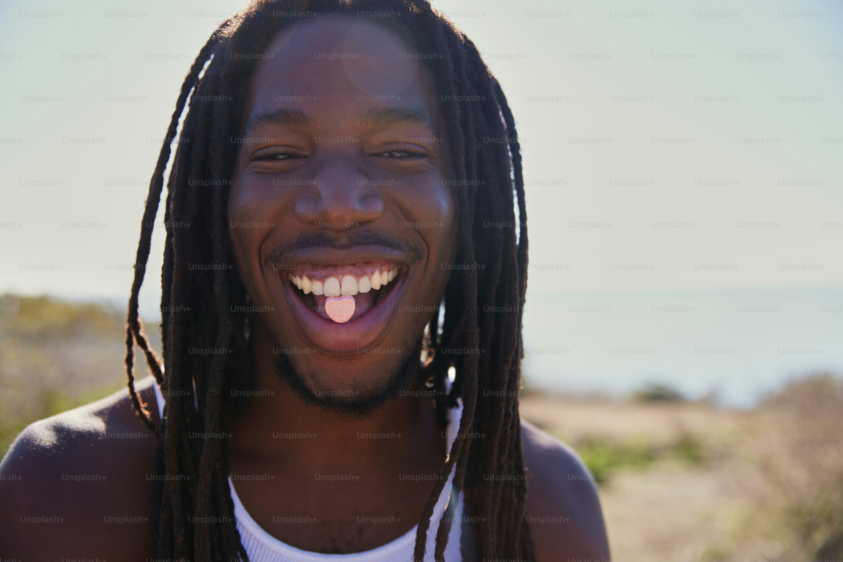 A man with dreadlocks smiles at the camera photo – Happy Image on Unsplash