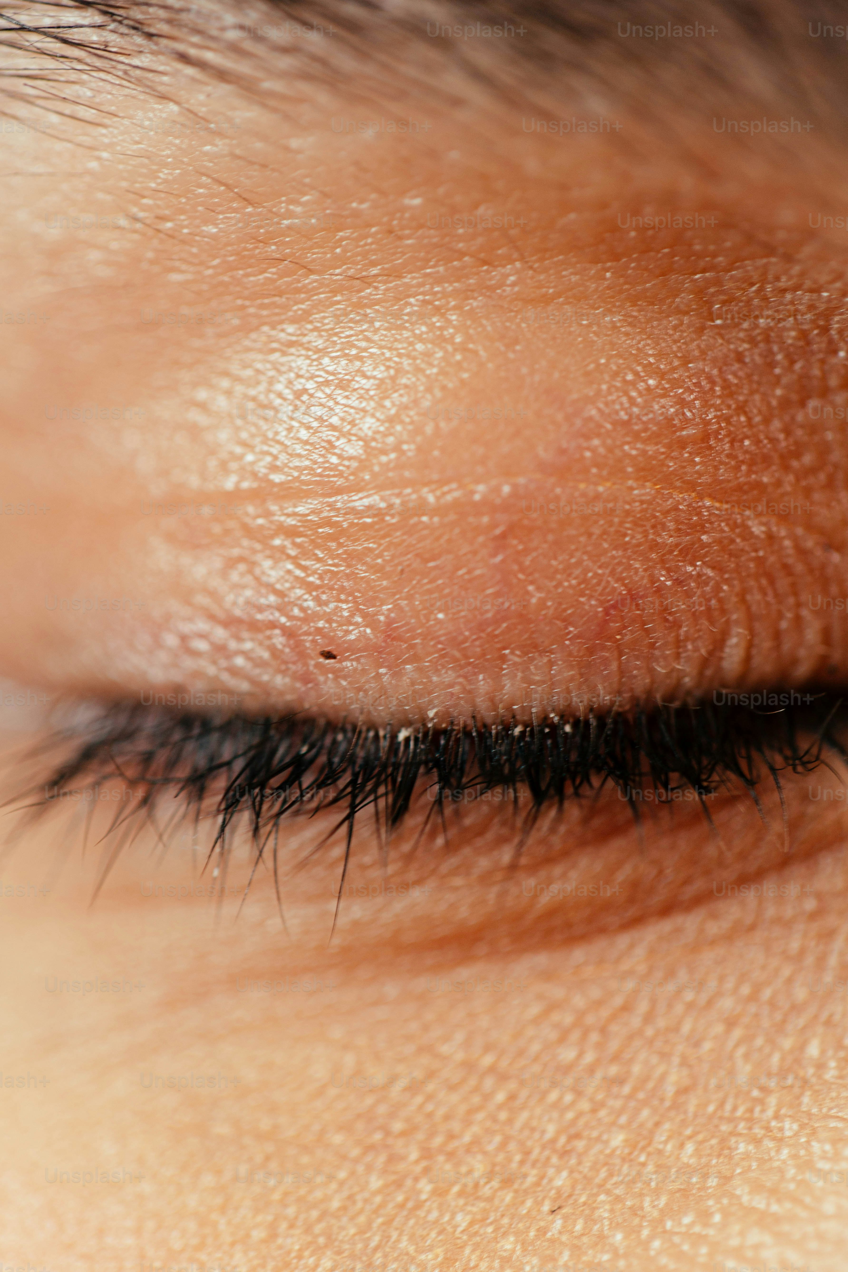 A close up of a person's eye with long eyelashes photo – Oily skin ...