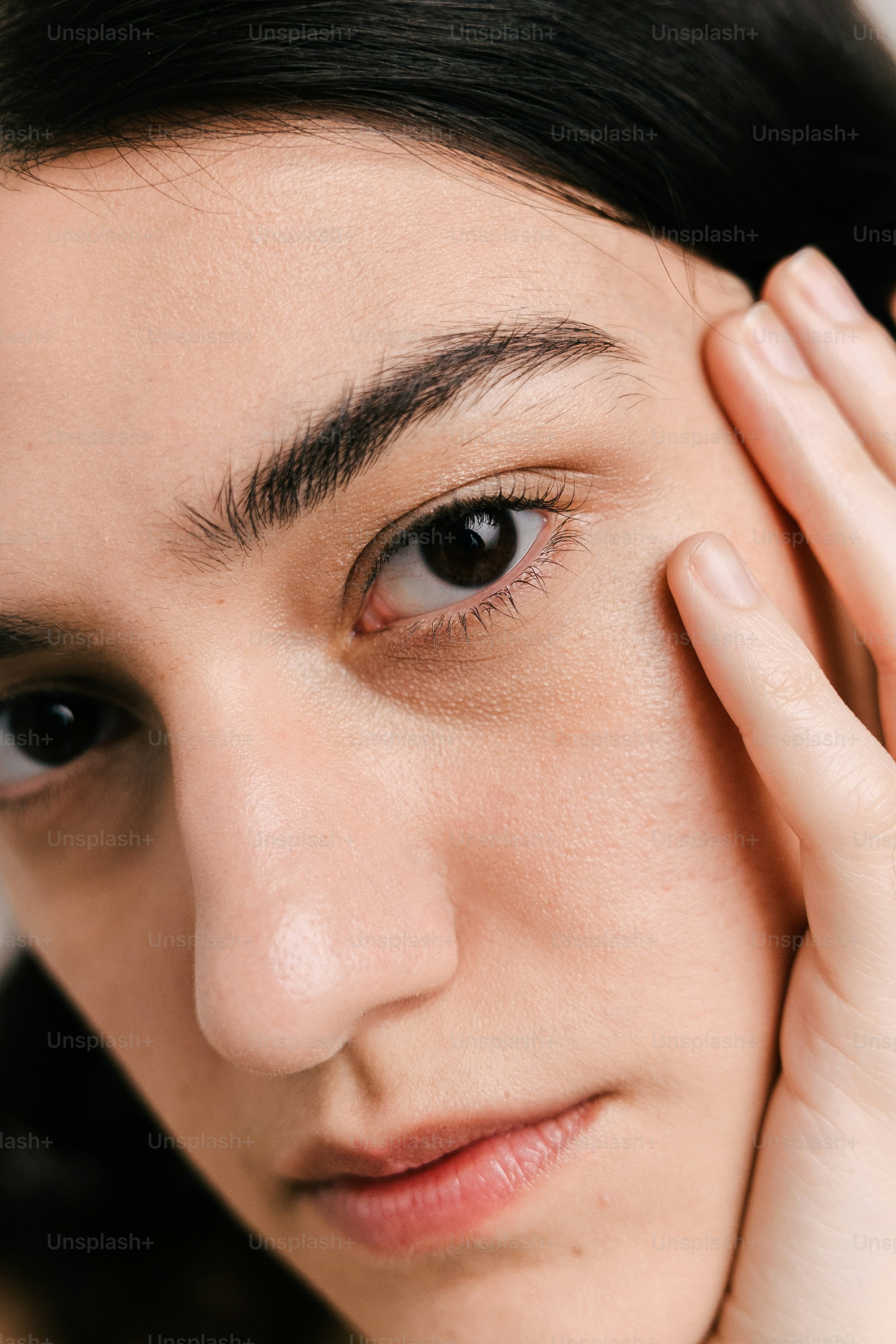 A close up of a woman's face with a ring on her finger photo – Portrait ...