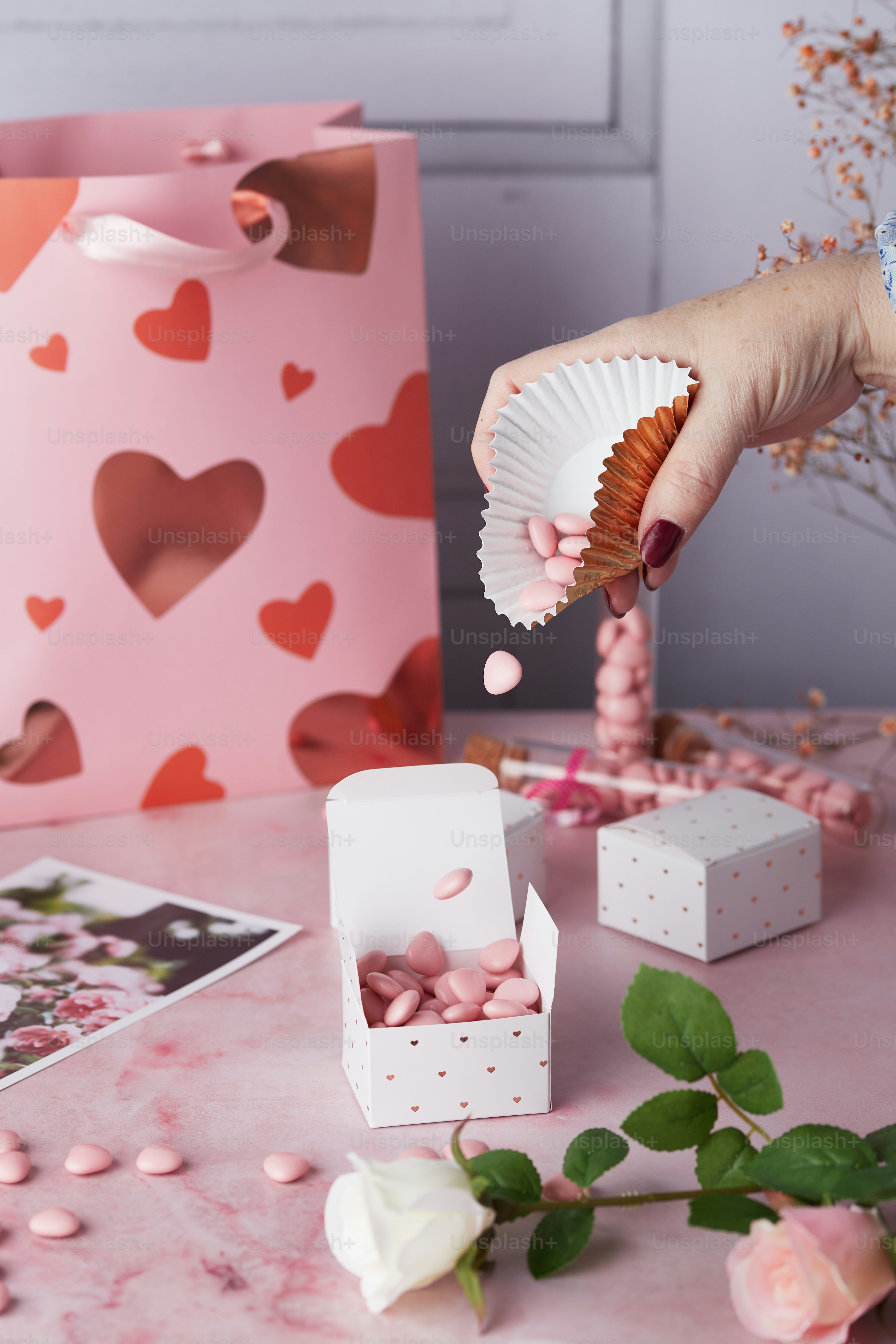 A person holding a paper fan over a box of candy photo – Sweets Image ...