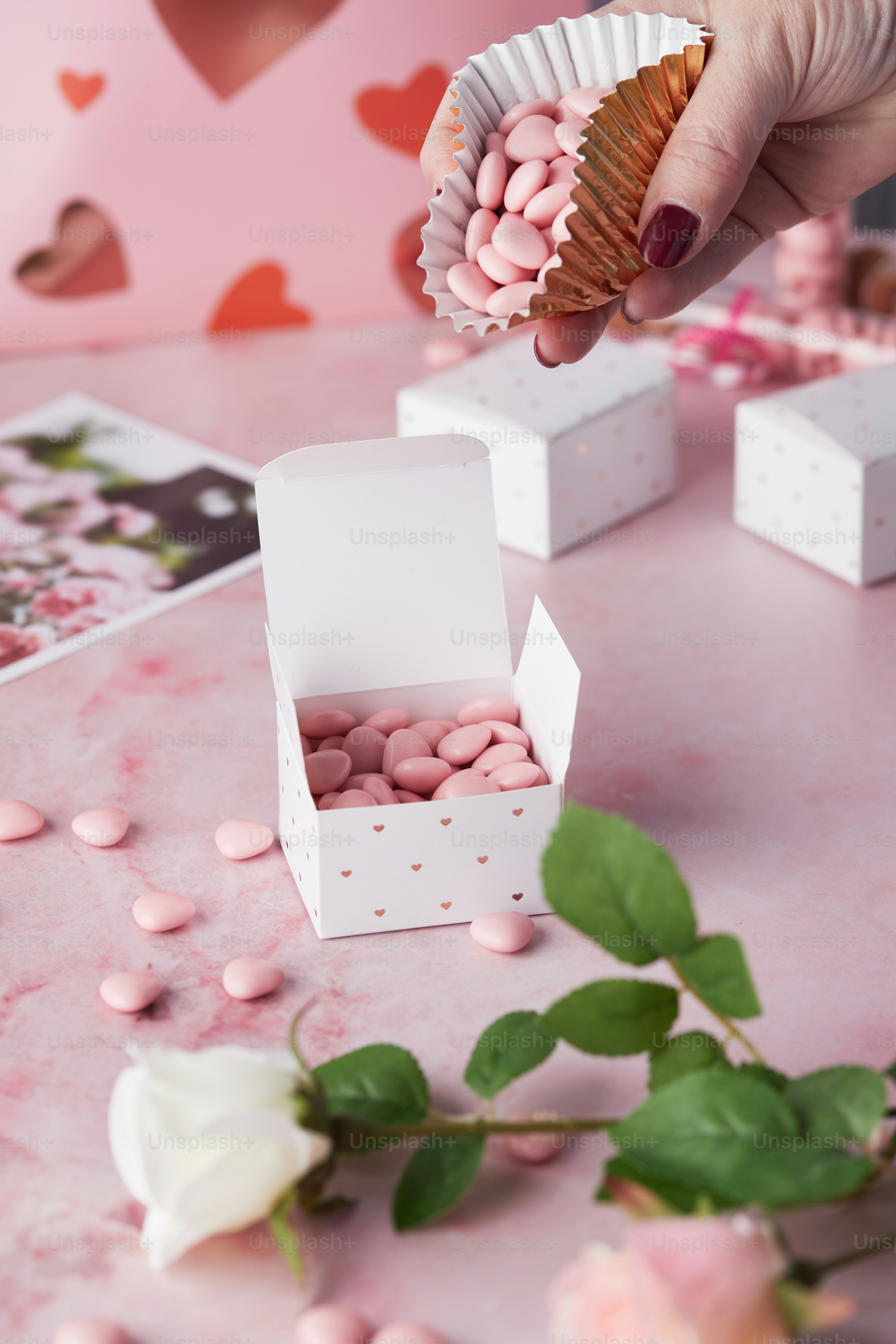 A person holding a pastry in a box on a table photo – Sweets Image on ...