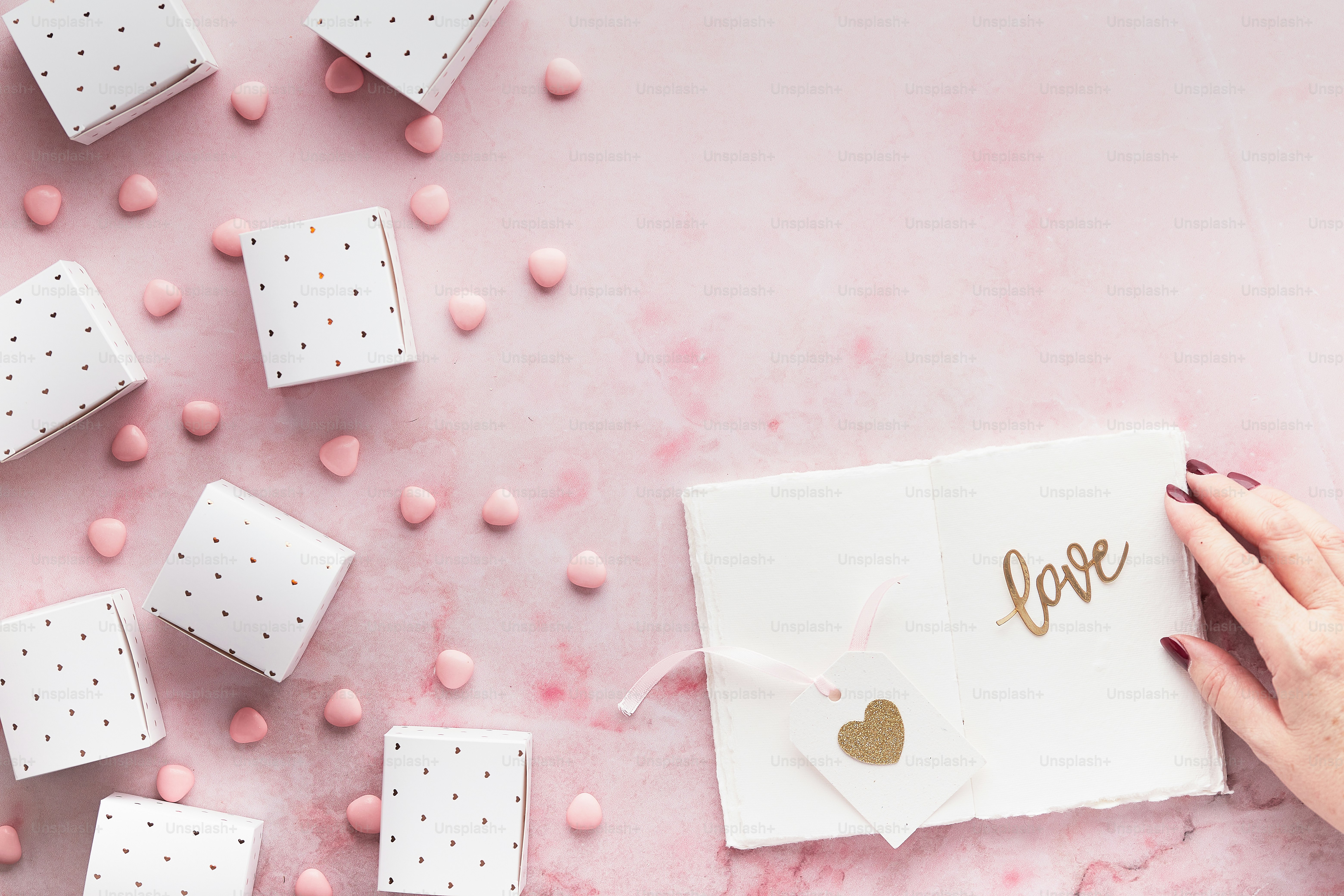A person holding a piece of paper over a box photo – Pink love Image on ...