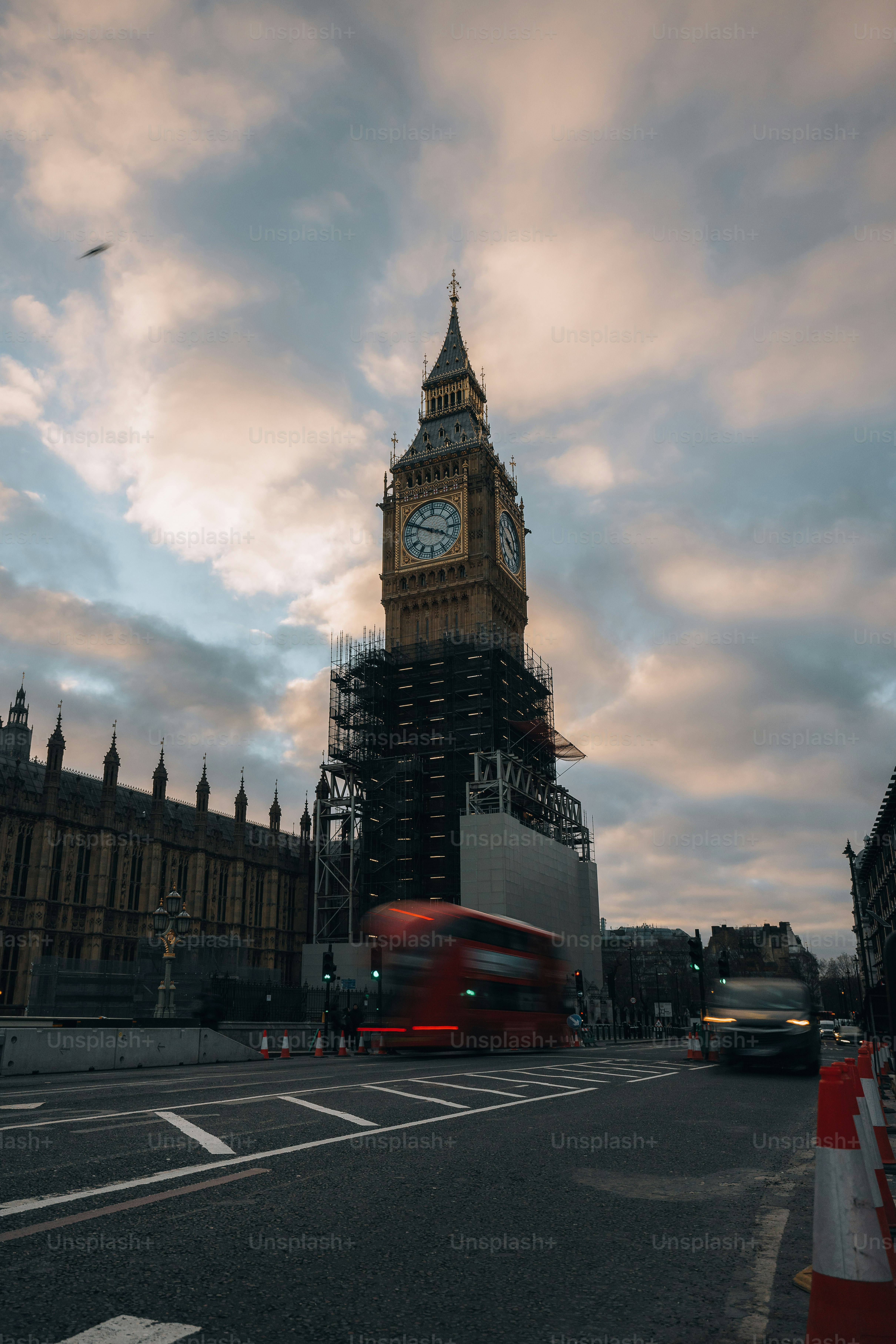 A large clock tower under a cloudy sky photo – Exteriors Image on Unsplash