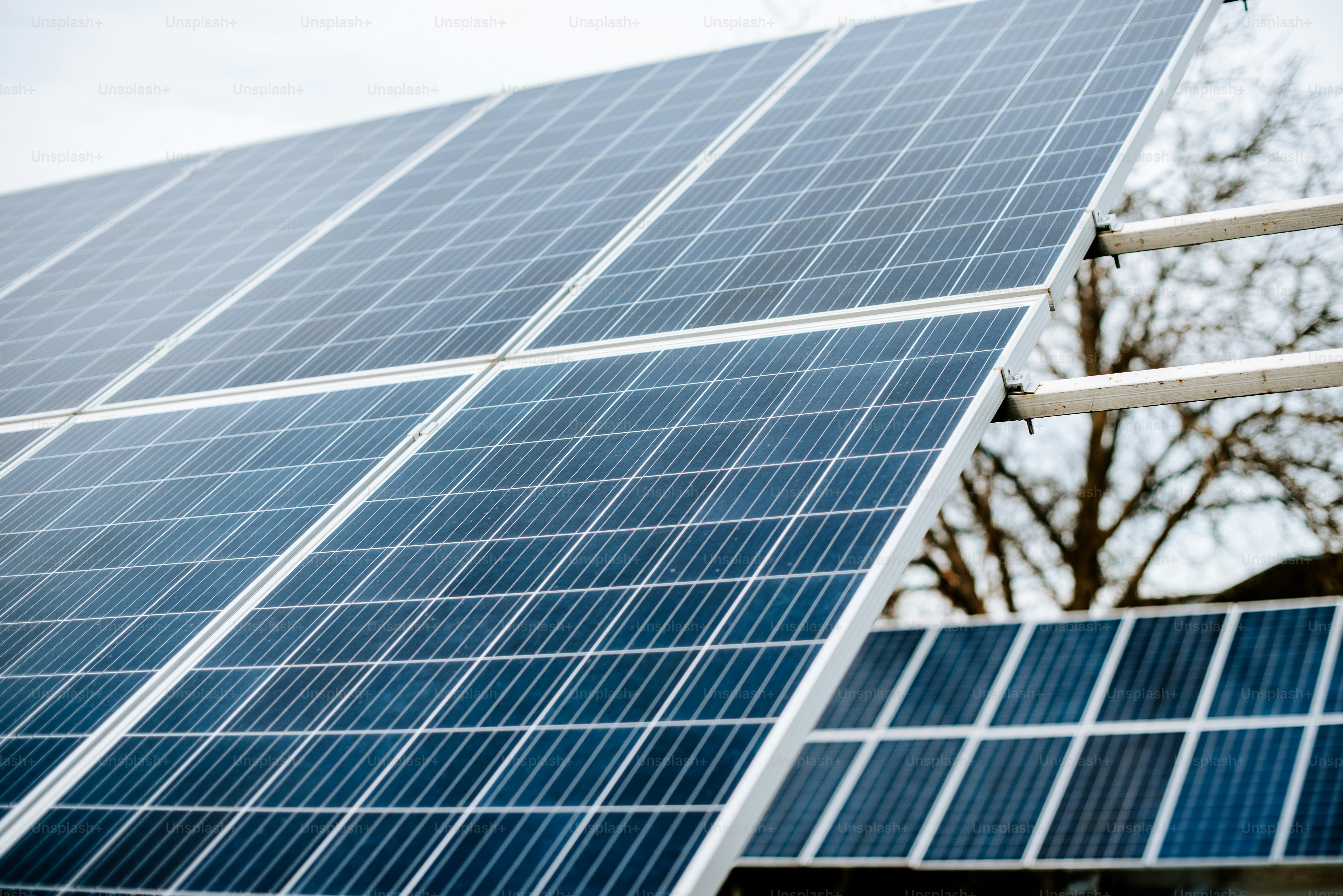 A tall building with a bunch of solar panels on it photo – Professional ...