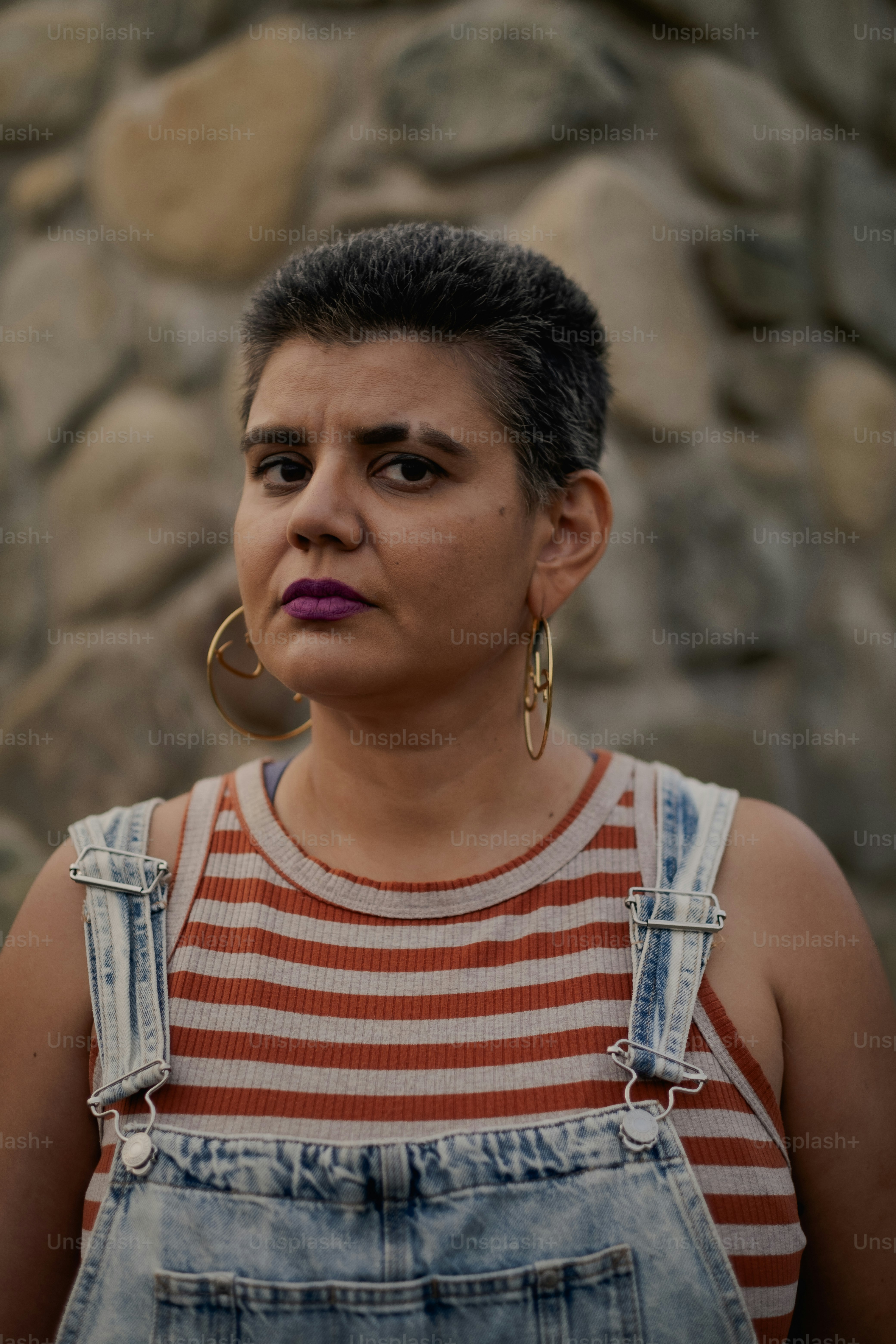 A woman wearing overalls and a striped shirt photo – Lgbt Image on Unsplash
