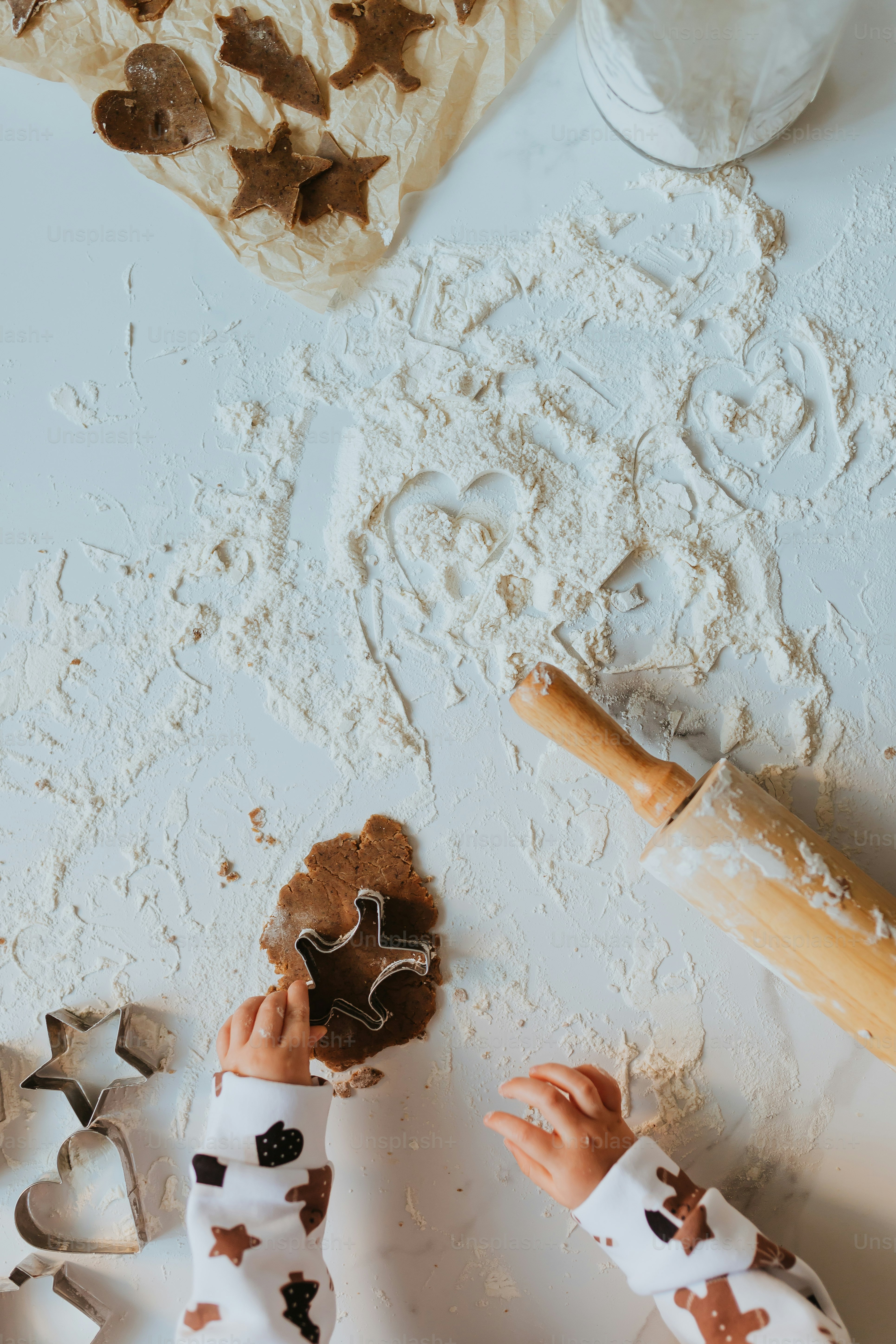 A child is making cookies with a cookie cutter photo – Baking Image on ...