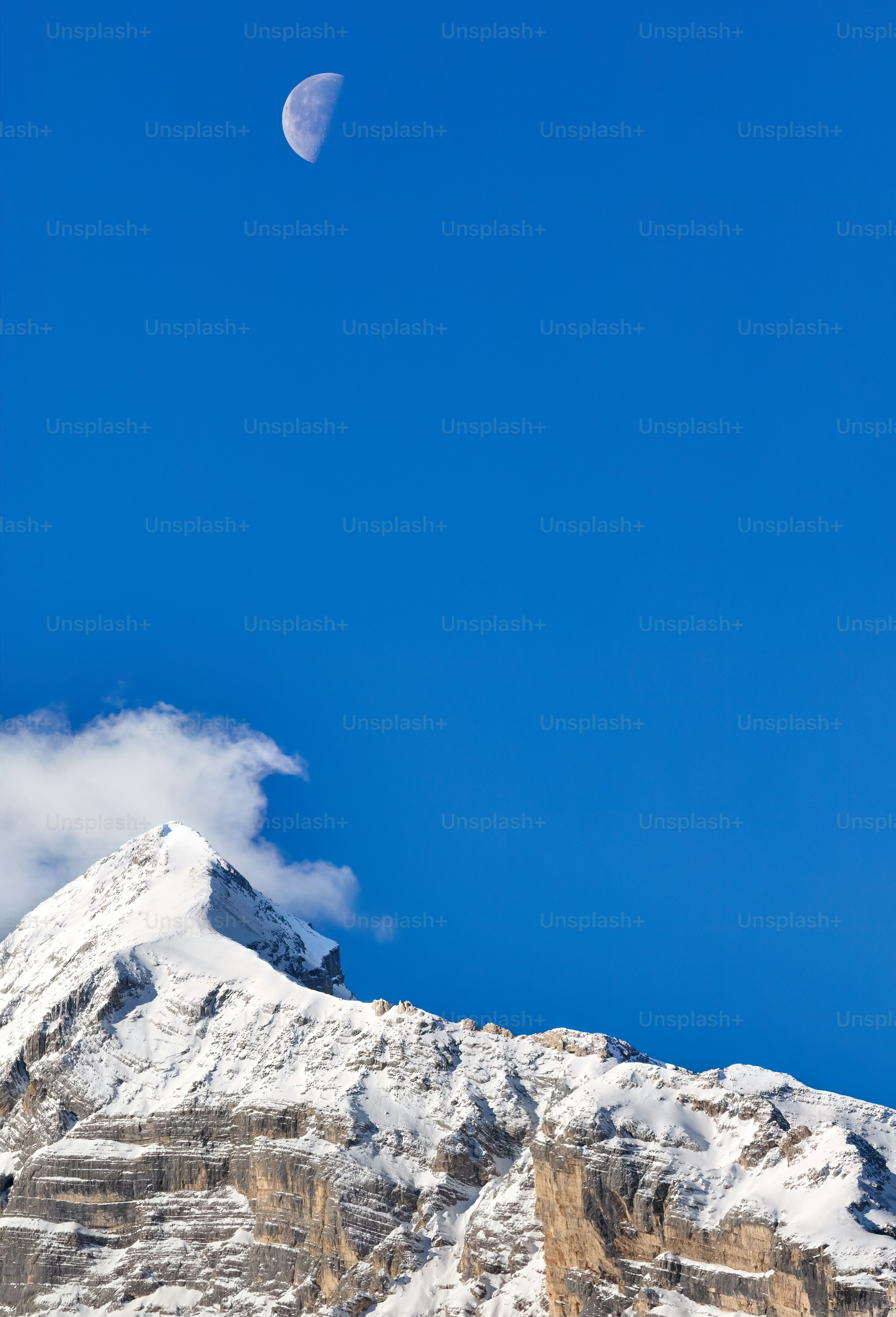 A mountain with a half moon in the sky photo – Winter Image on Unsplash