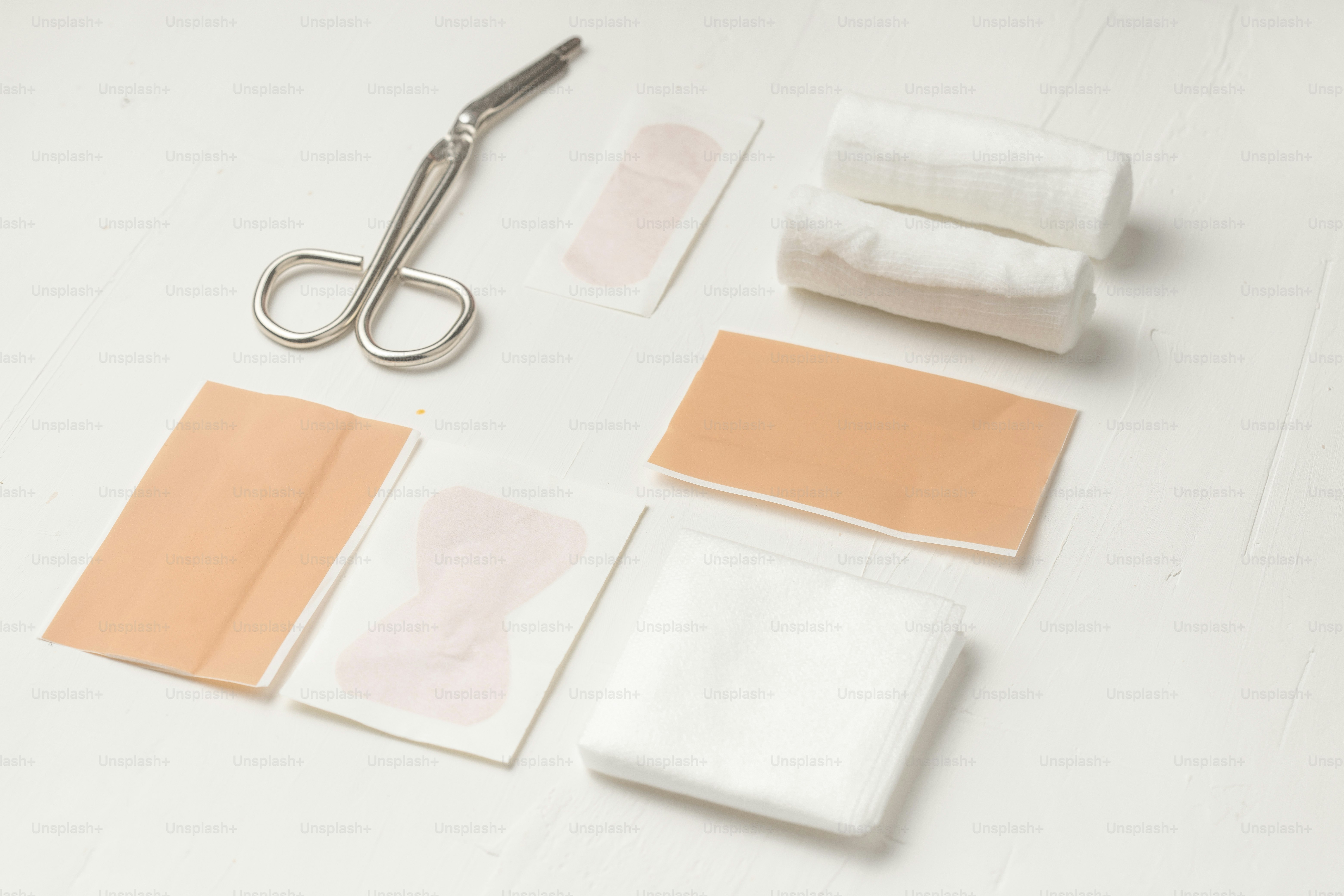 A pair of scissors and some pieces of paper photo – Bandages Image on ...