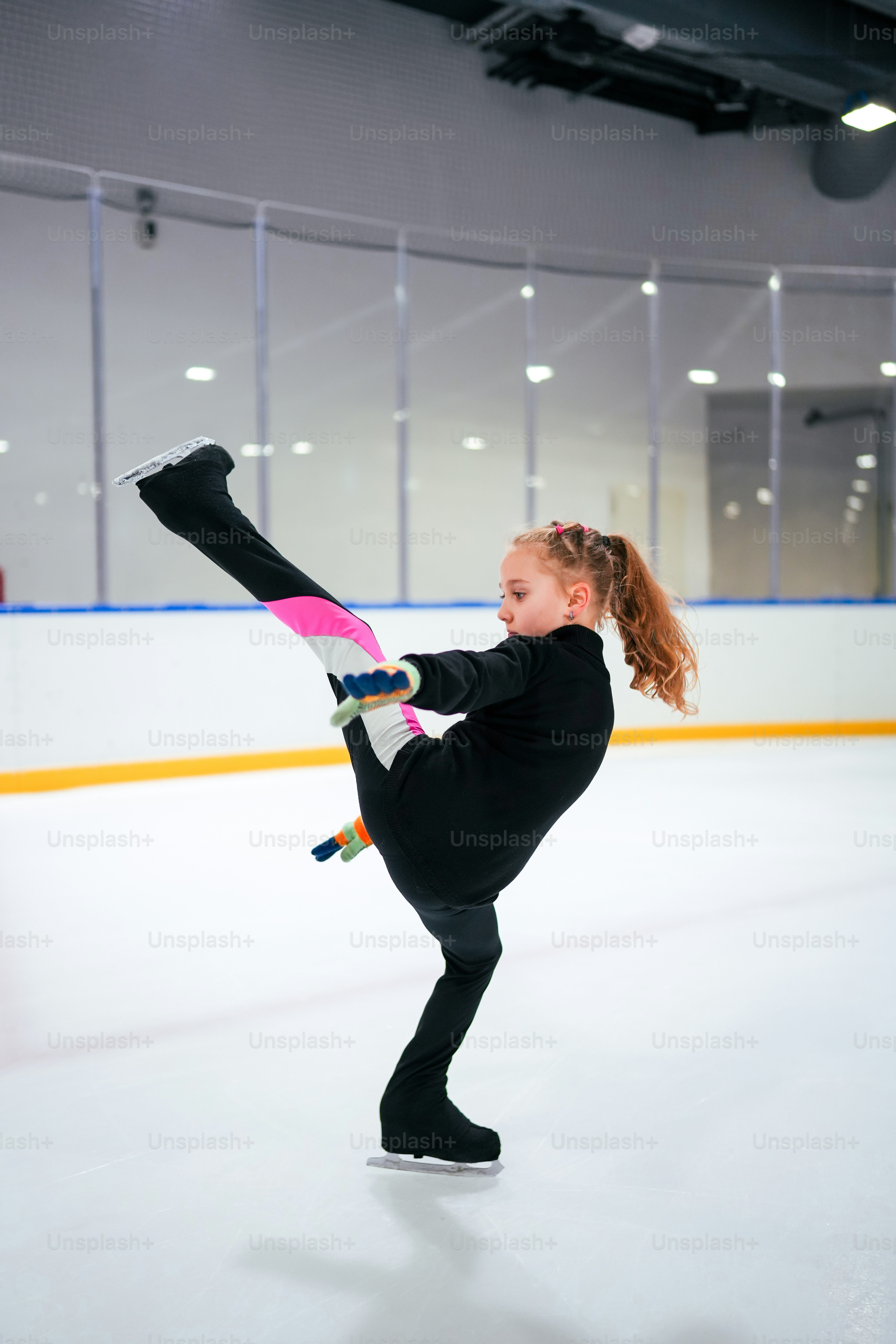 A woman is doing a handstand on an ice rink photo – Figure skating ...