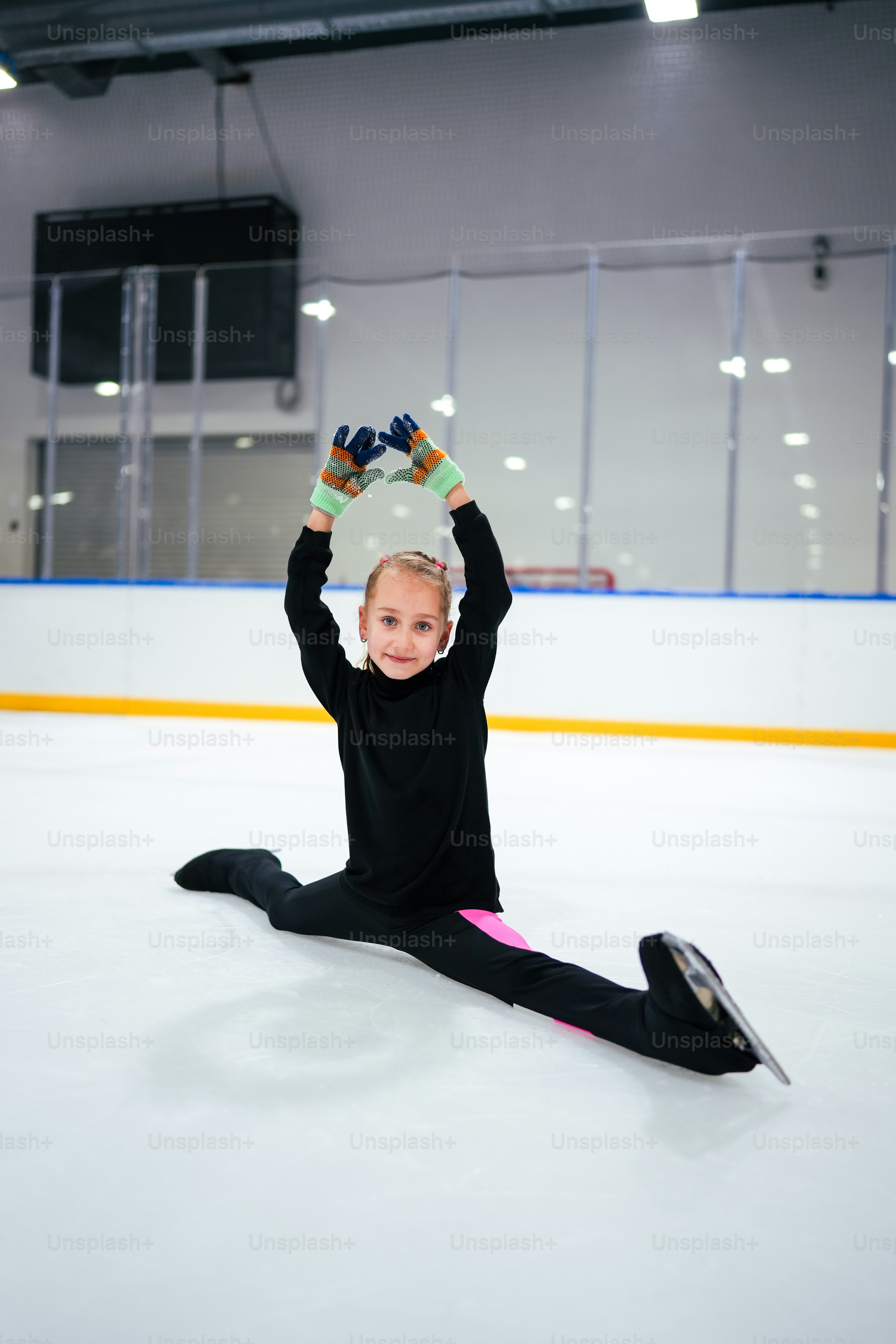A woman is doing a handstand on an ice rink photo – Figure skating ...